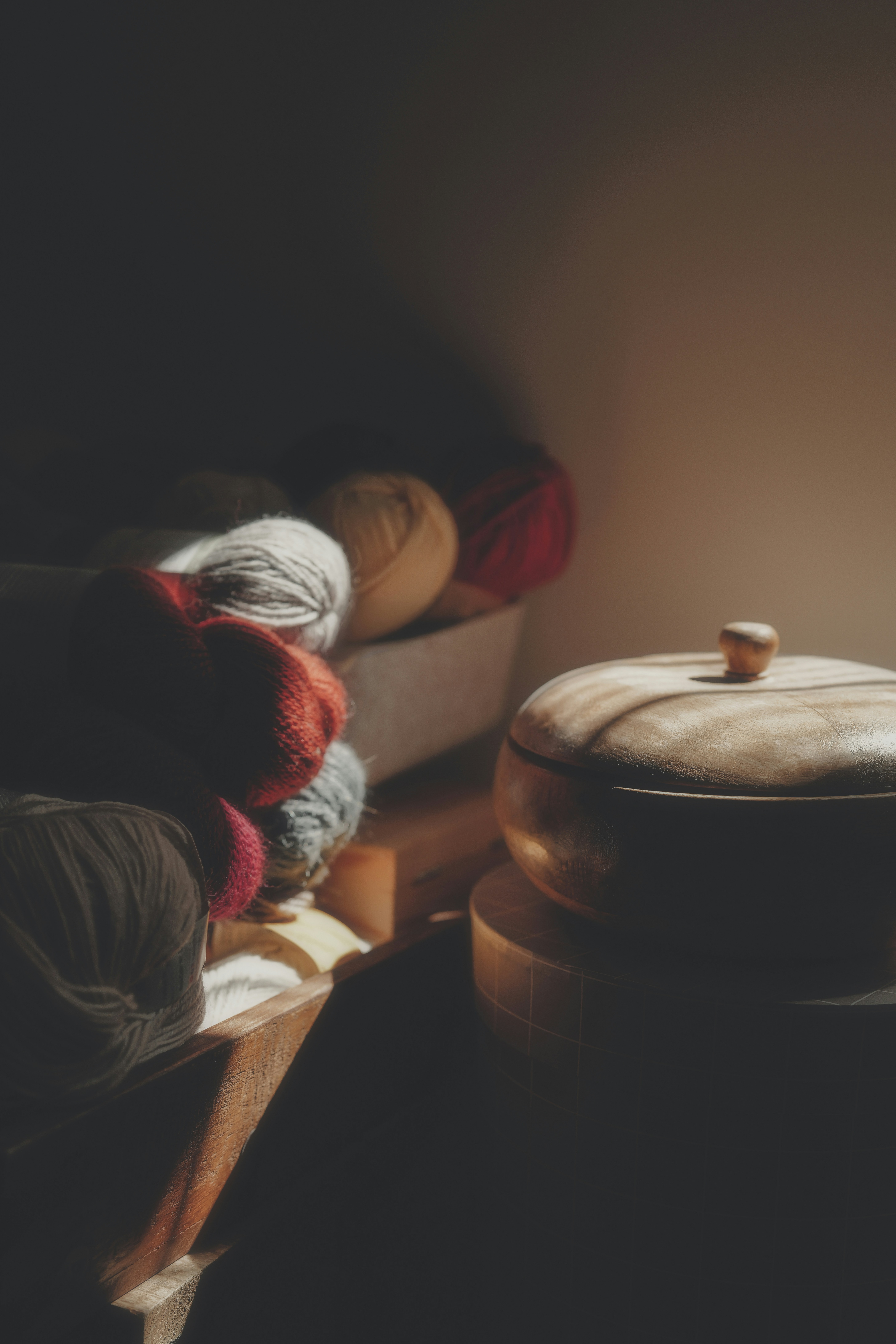 Cozy Knit Corner: Spools of Color Beside a Rustic Pot