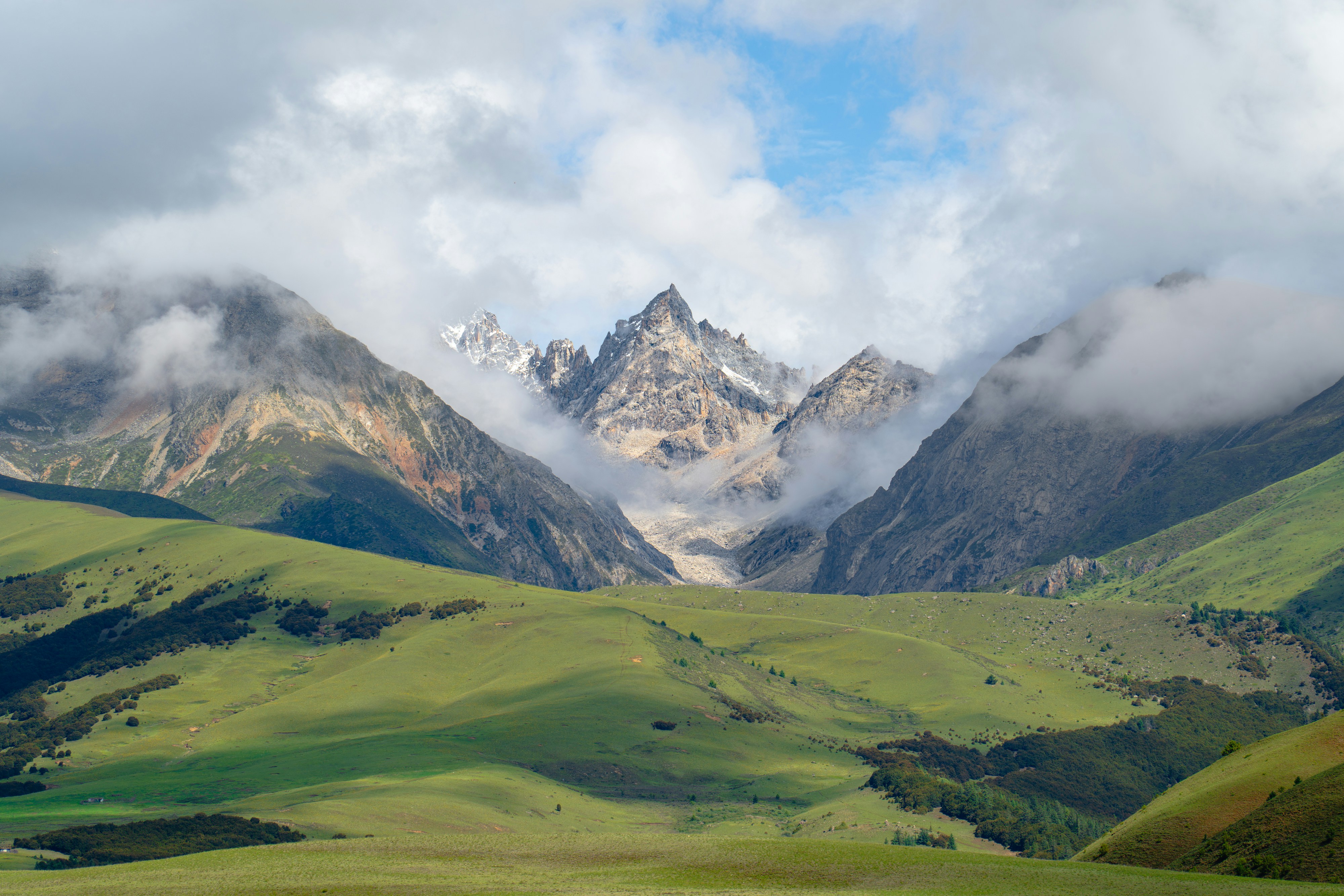Snow-Kissed Peaks Emerging from a Whispering Valley