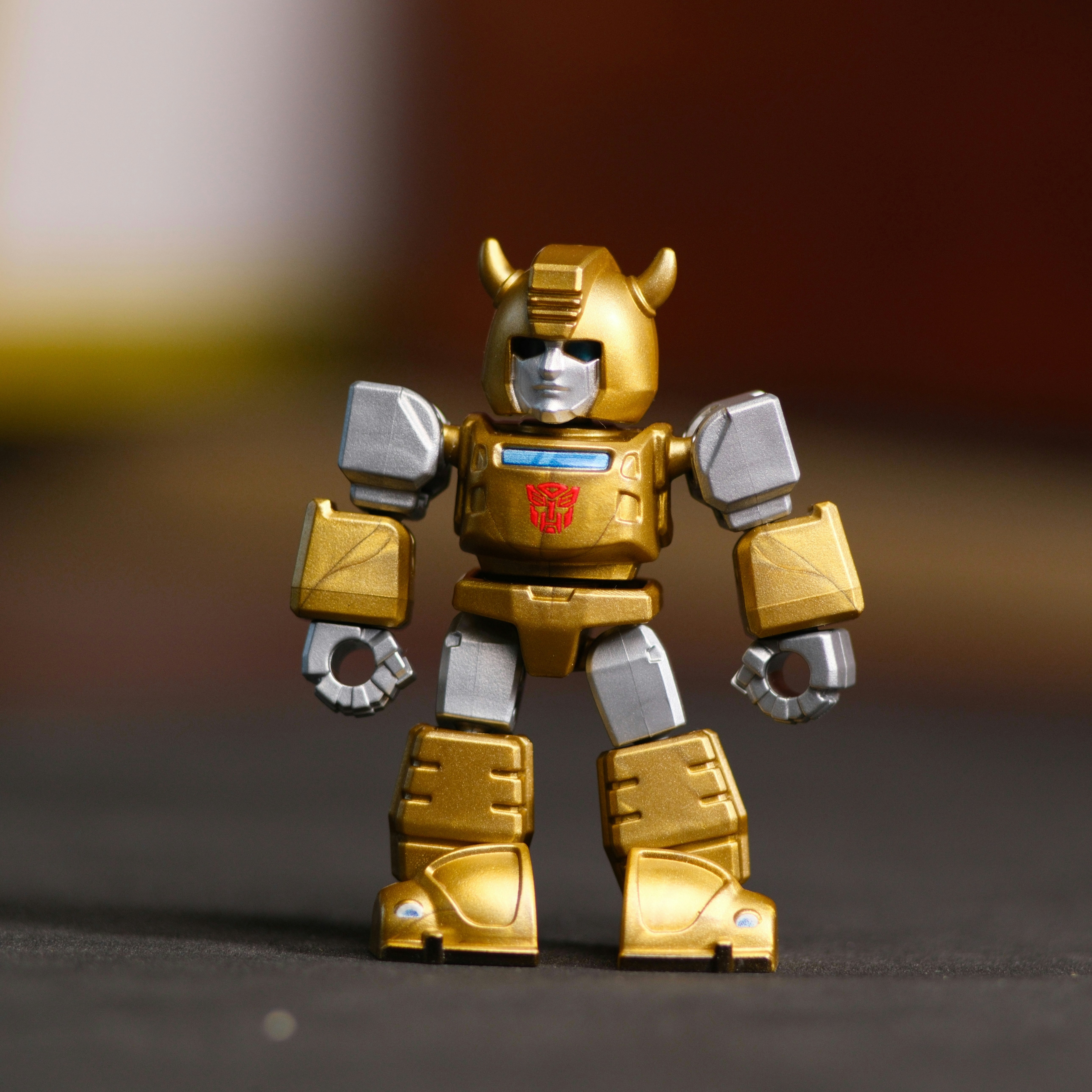 Miniature Gold Transformer Stands Proud on a Quiet Surface