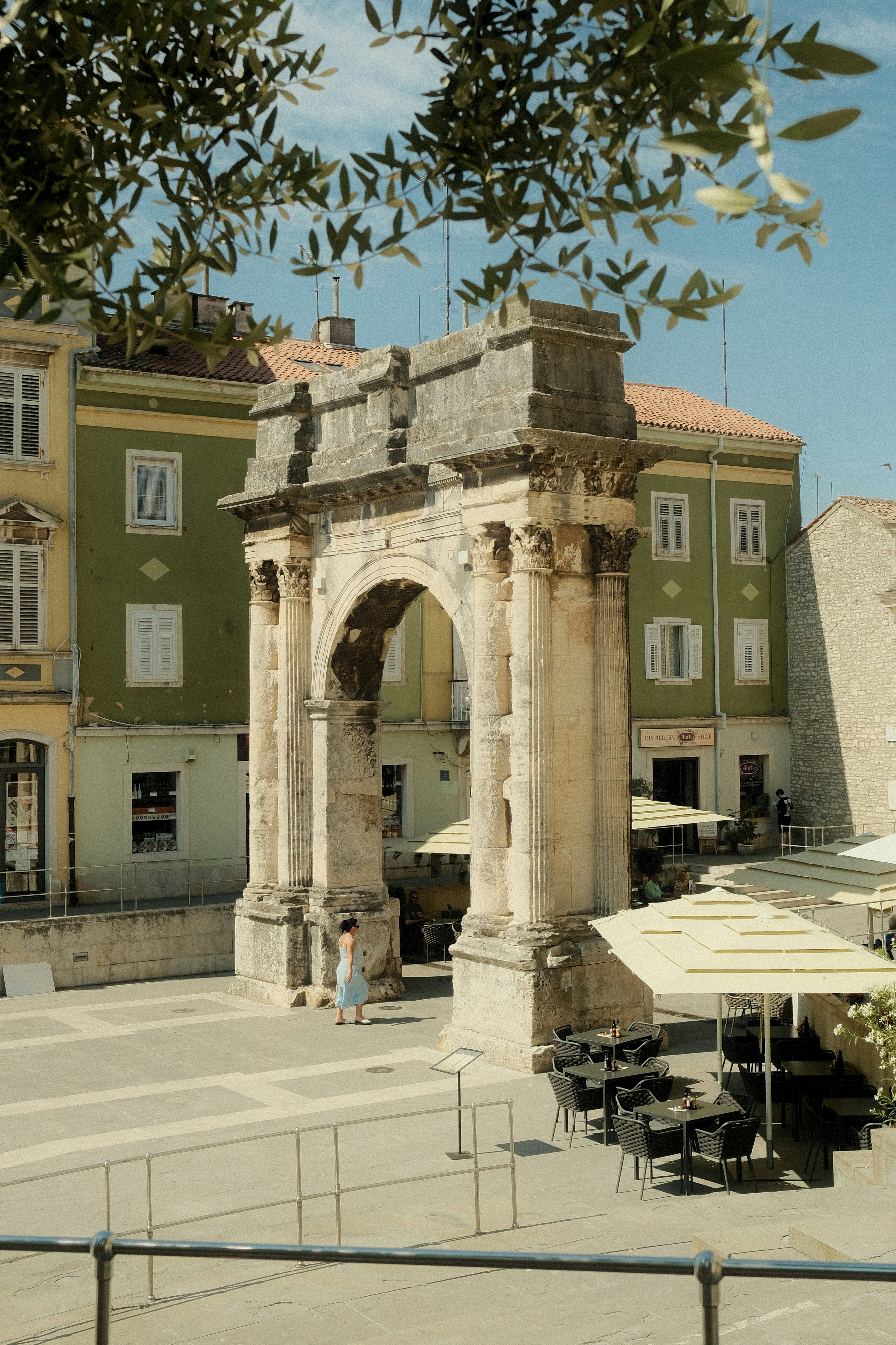 Ancient Archway Framed by Mediterranean Piazza