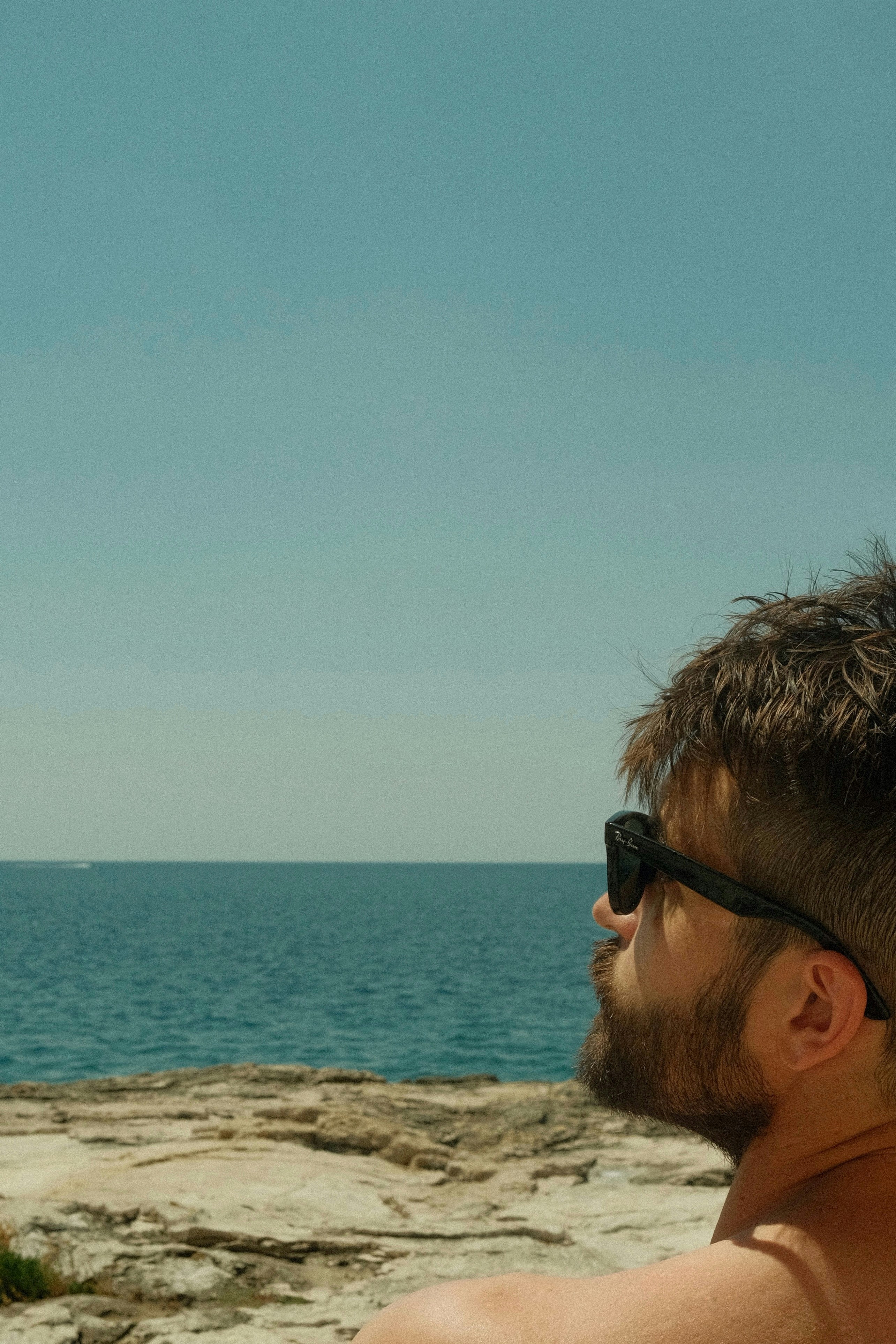 Coastal Gaze: Sunglasses, Sea, and Sunlight