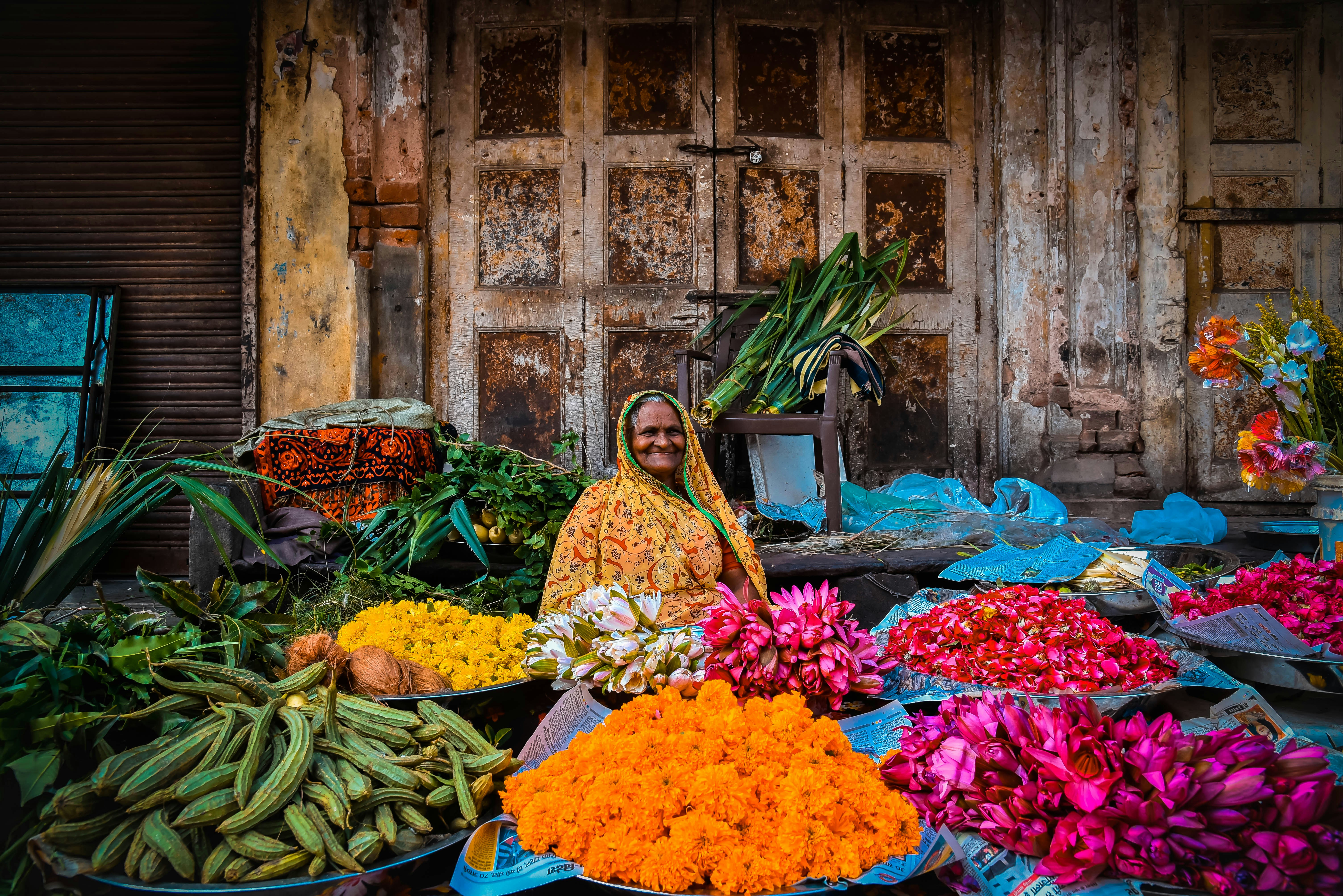 Vivid Vendor Among Bursting Bouquets at a Market Stall