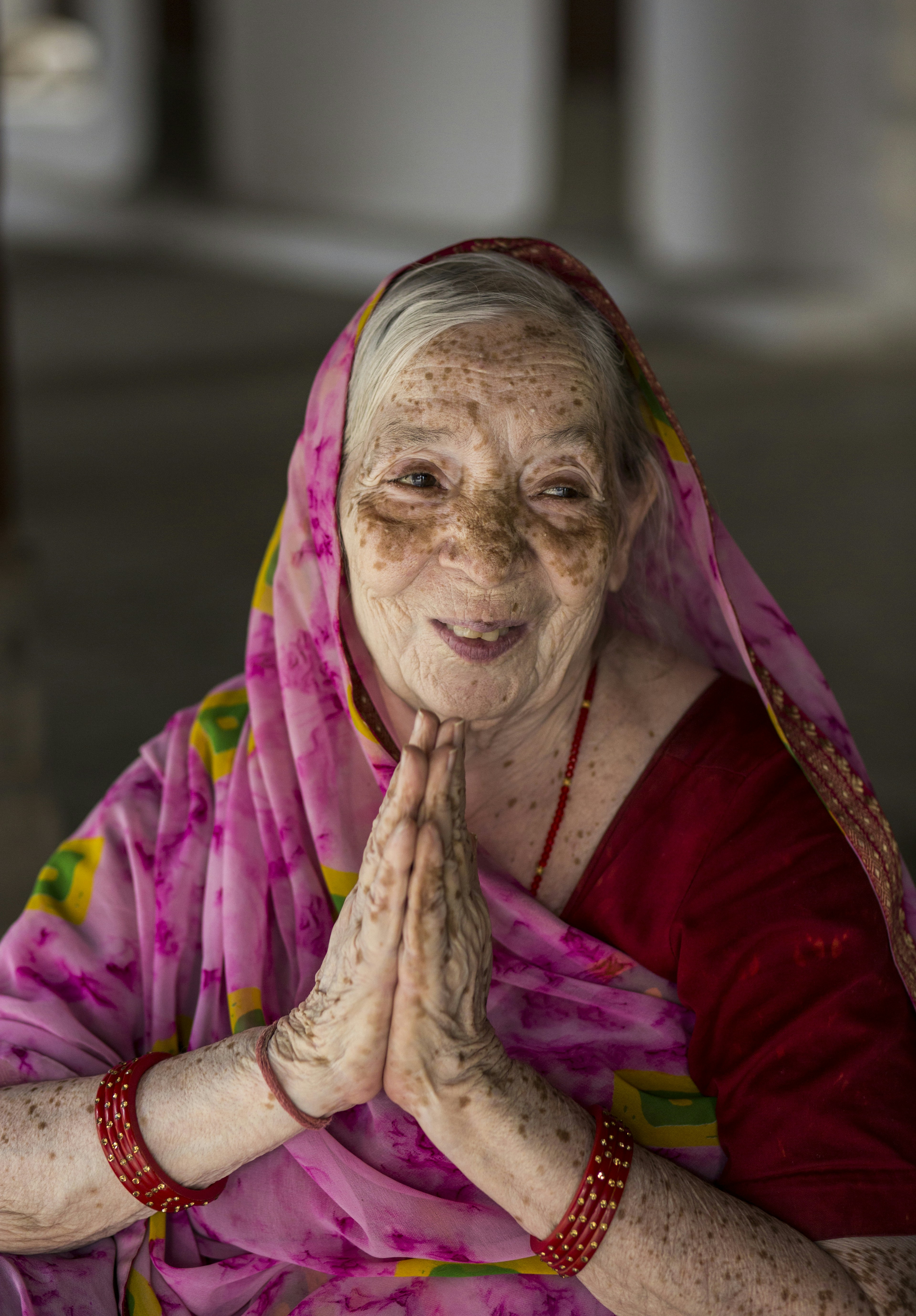 Graceful Namaste: A Wise Smile in Colorful Veils