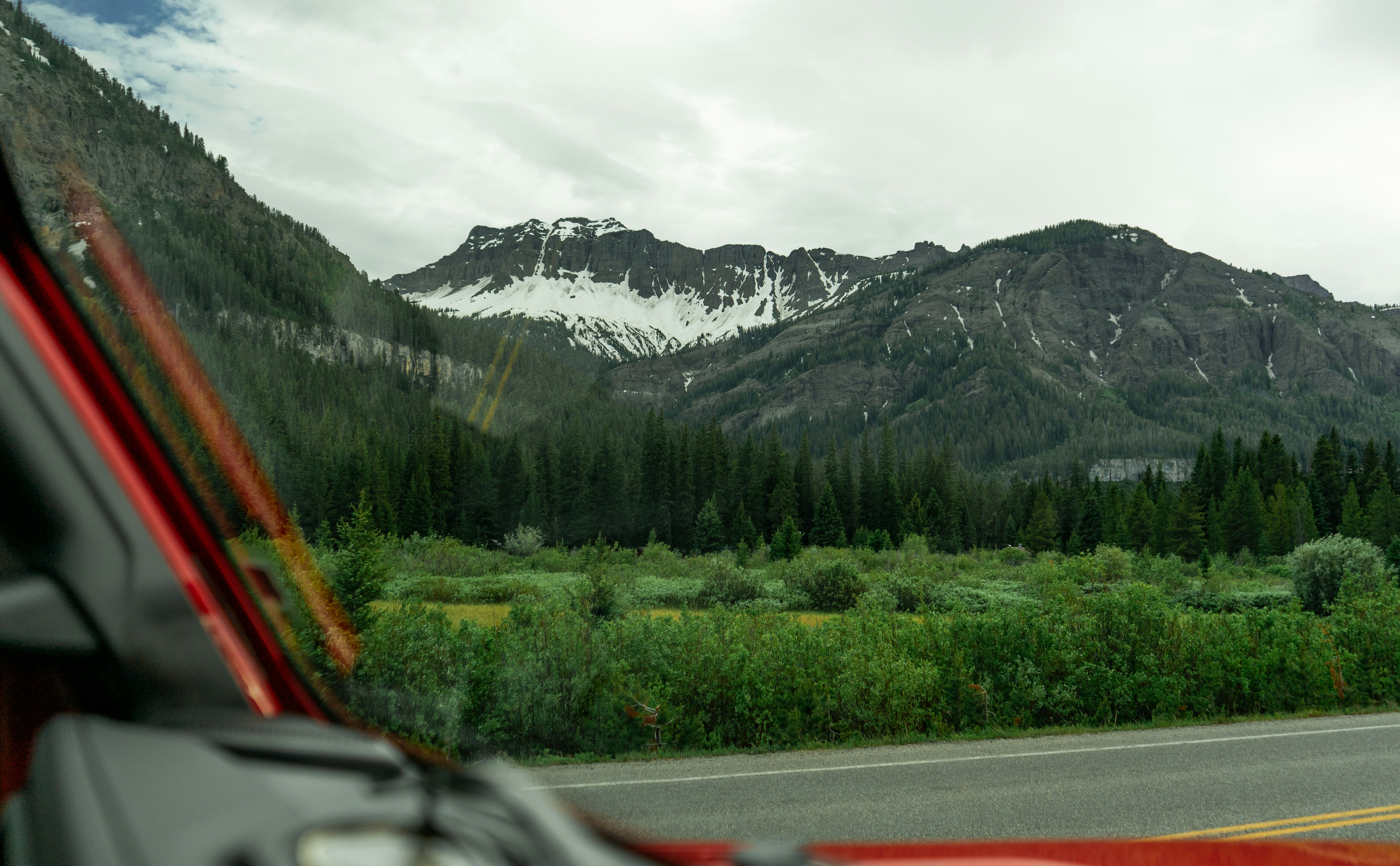 Snow-capped Peaks Framing a Deserted Roadside Vista