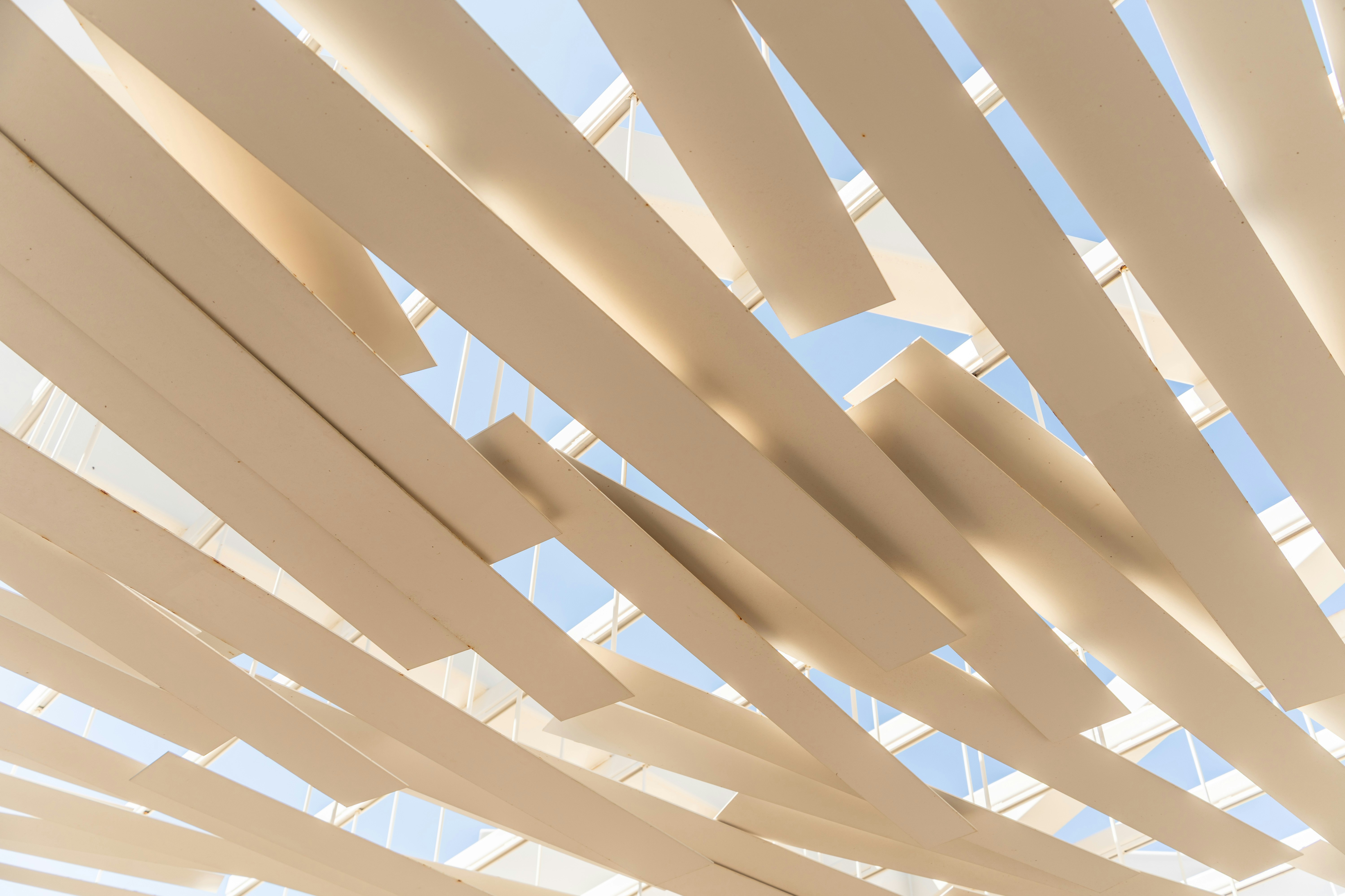 Sunlit Slats: Geometric Ribbons Against a Clear Sky