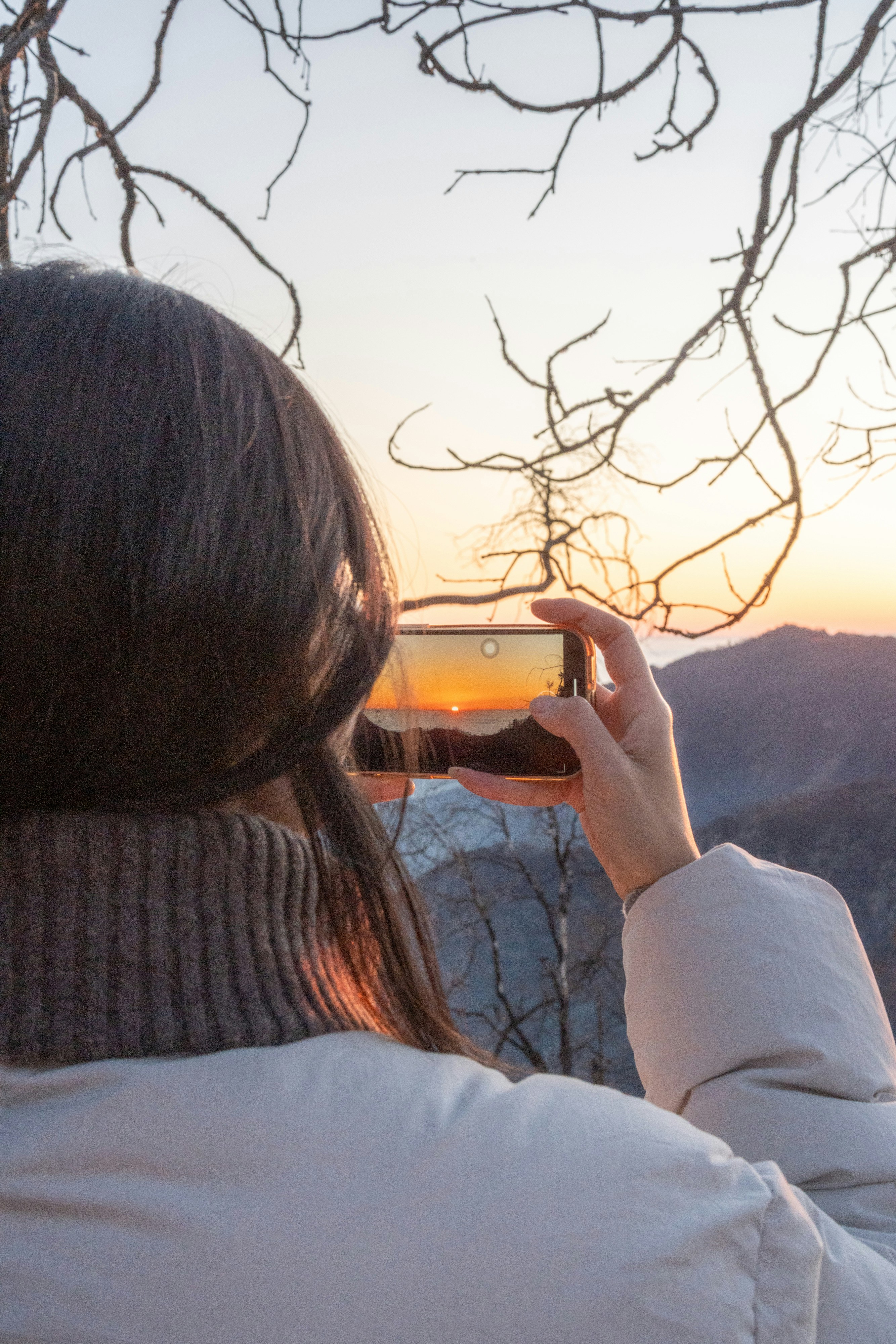 Sunset Portrait: Capturing a Moment Through a Phone Viewfinder