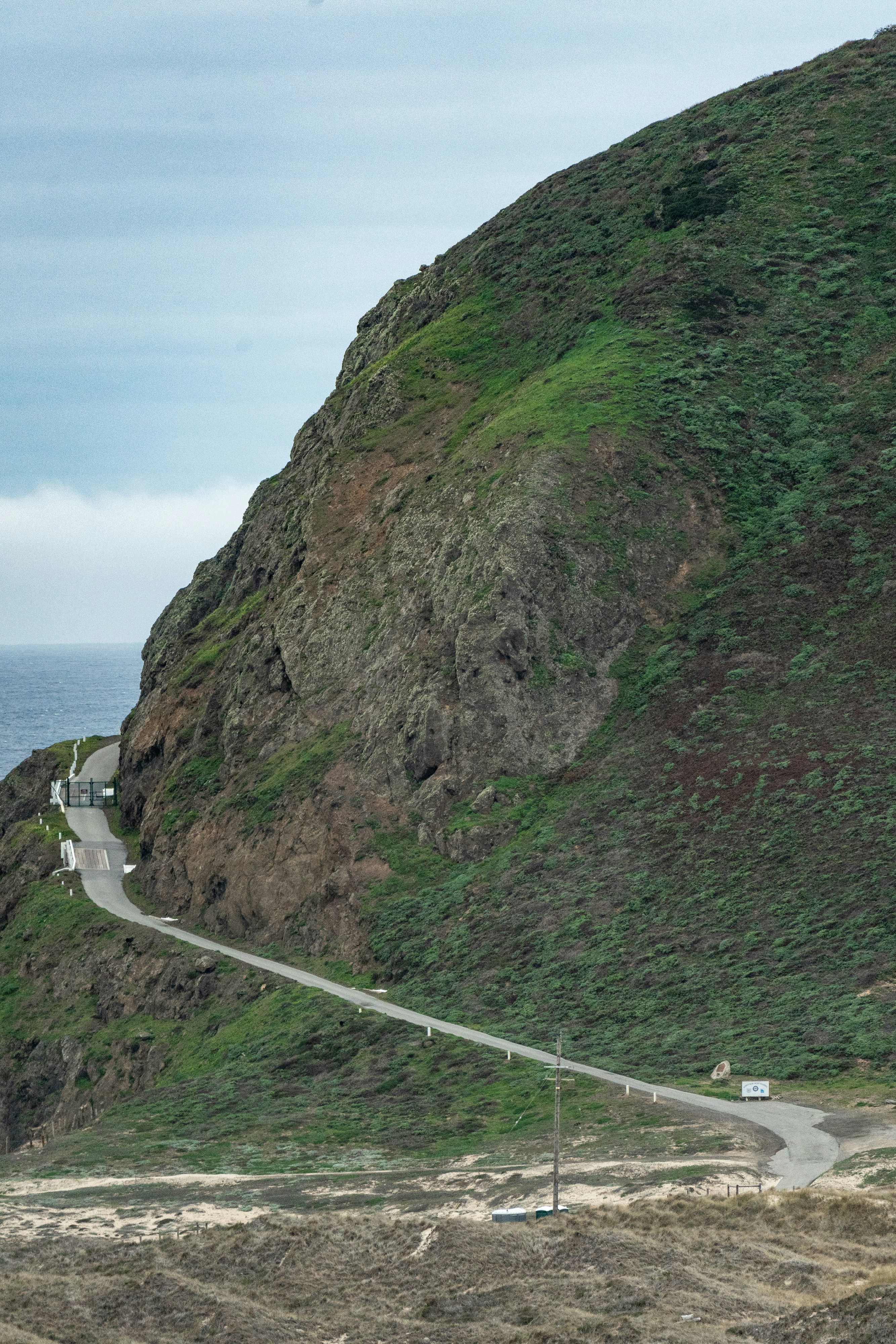 Coastal Road Winding along a Green Cliff