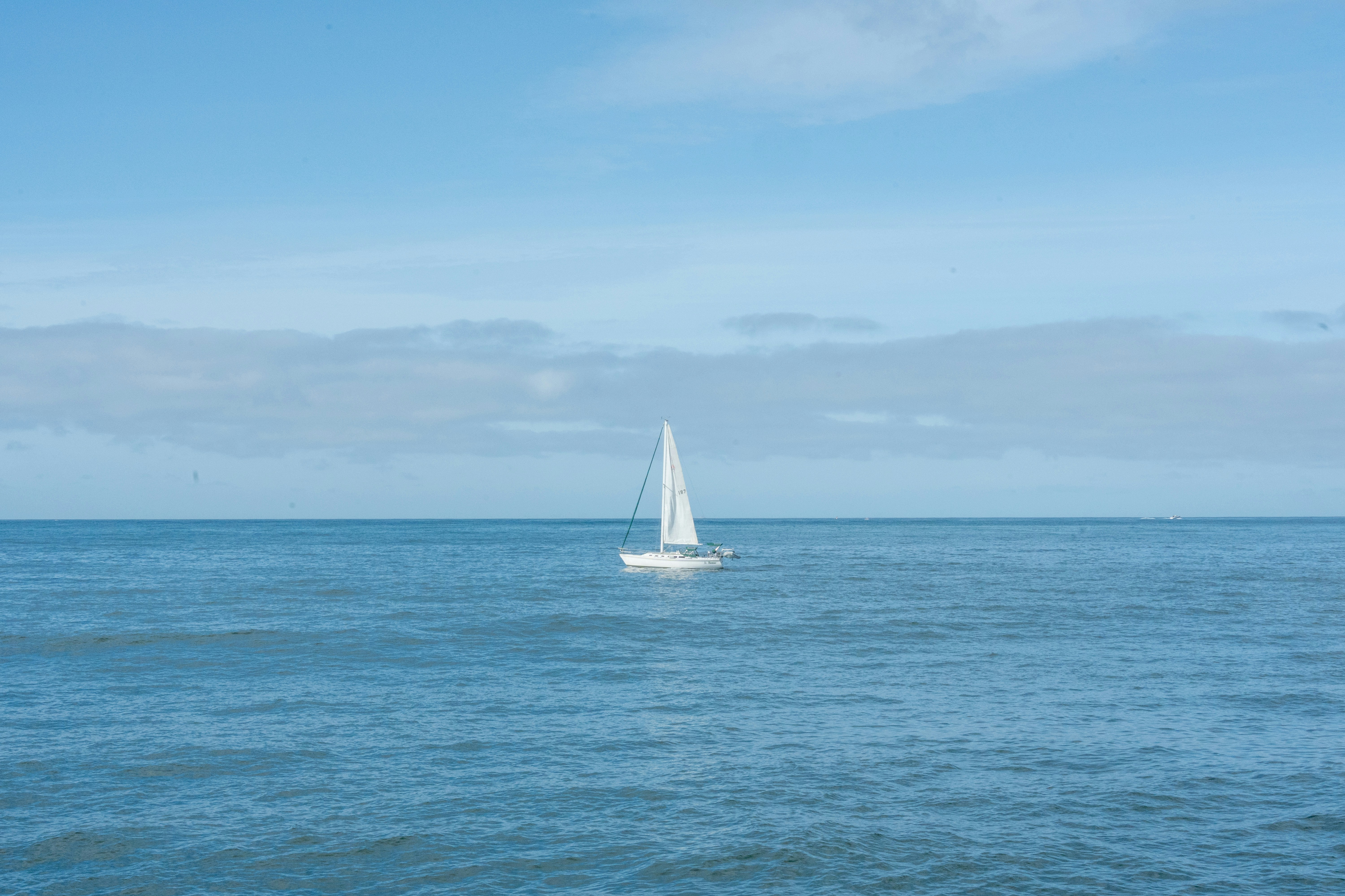 Solitary Sailboat on a Quiet Horizon