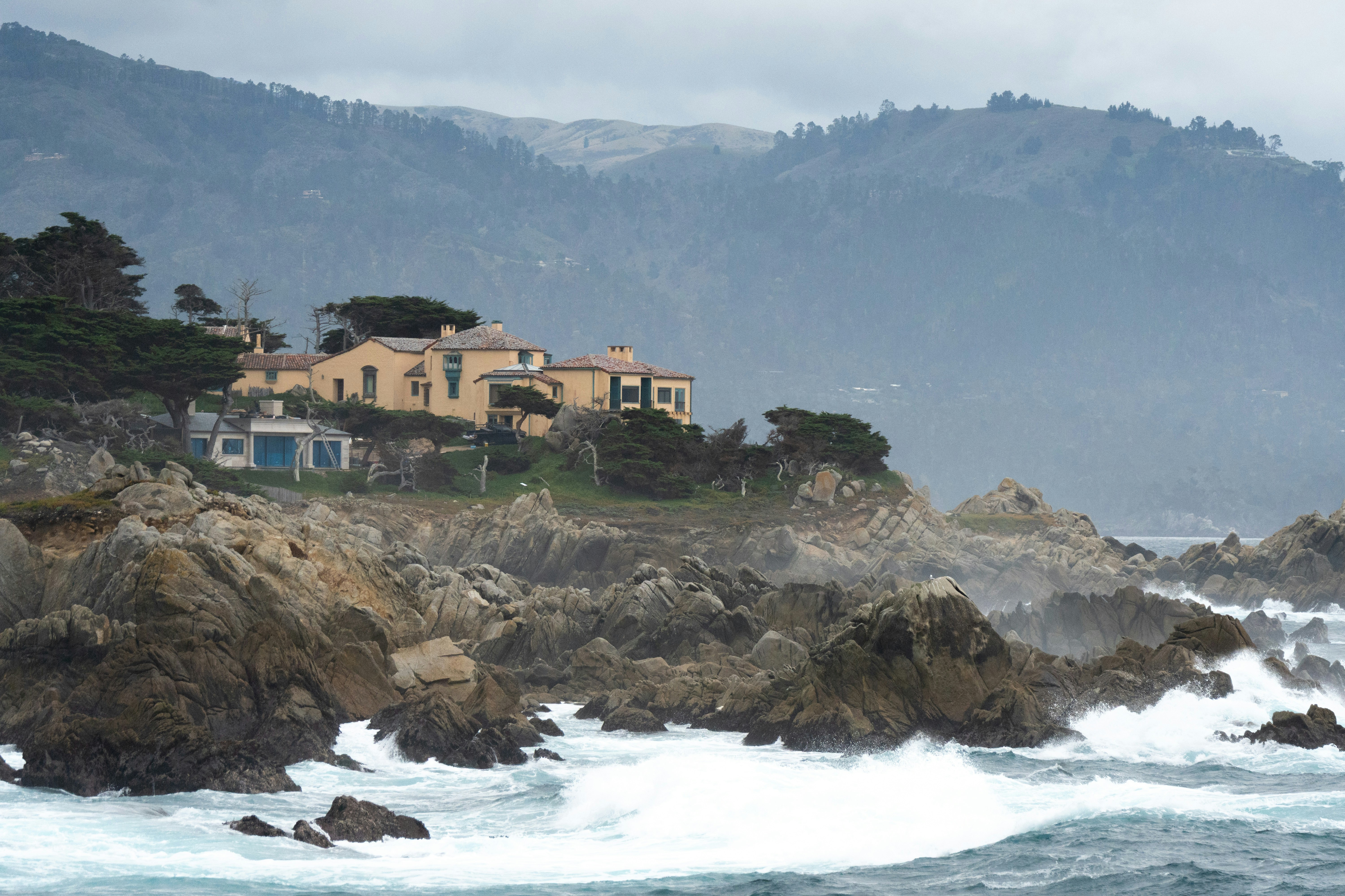 Coastal Retreat: Cliffside Villas Beside Rough Seas