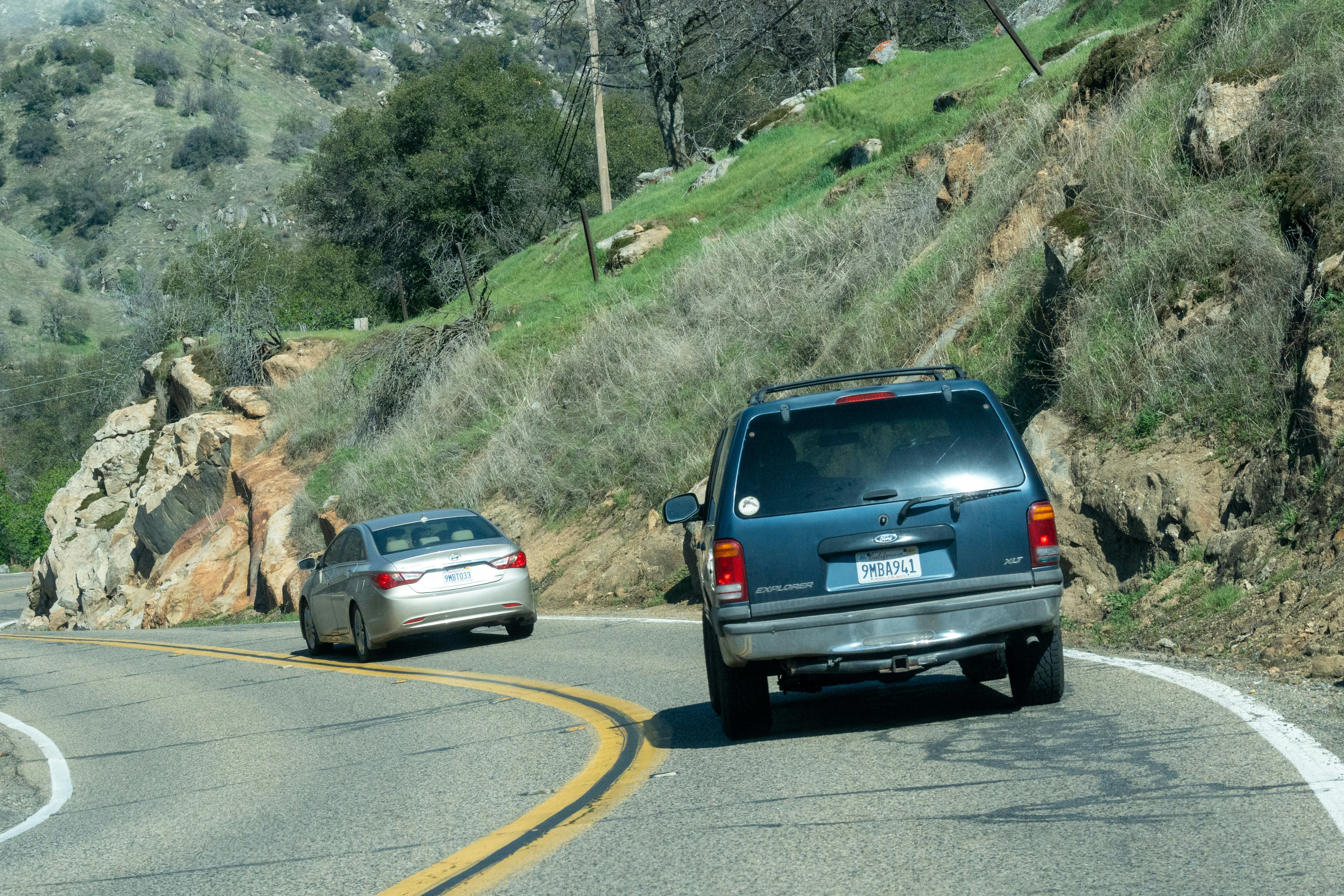 Toward the Curve: SUV on a Scenic Mountain Road