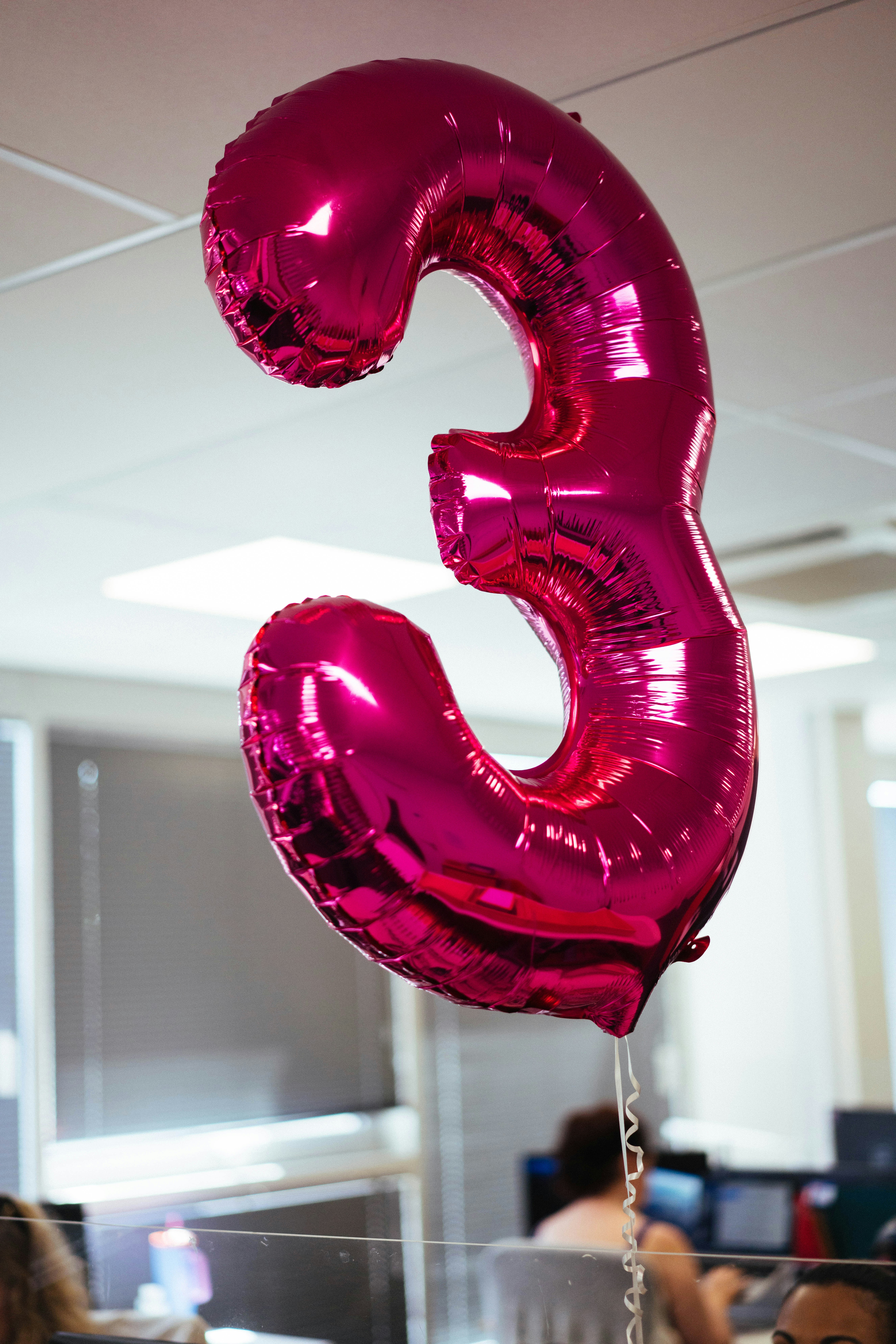 Magenta Balloon Numeral: A Floating Celebration in an Office