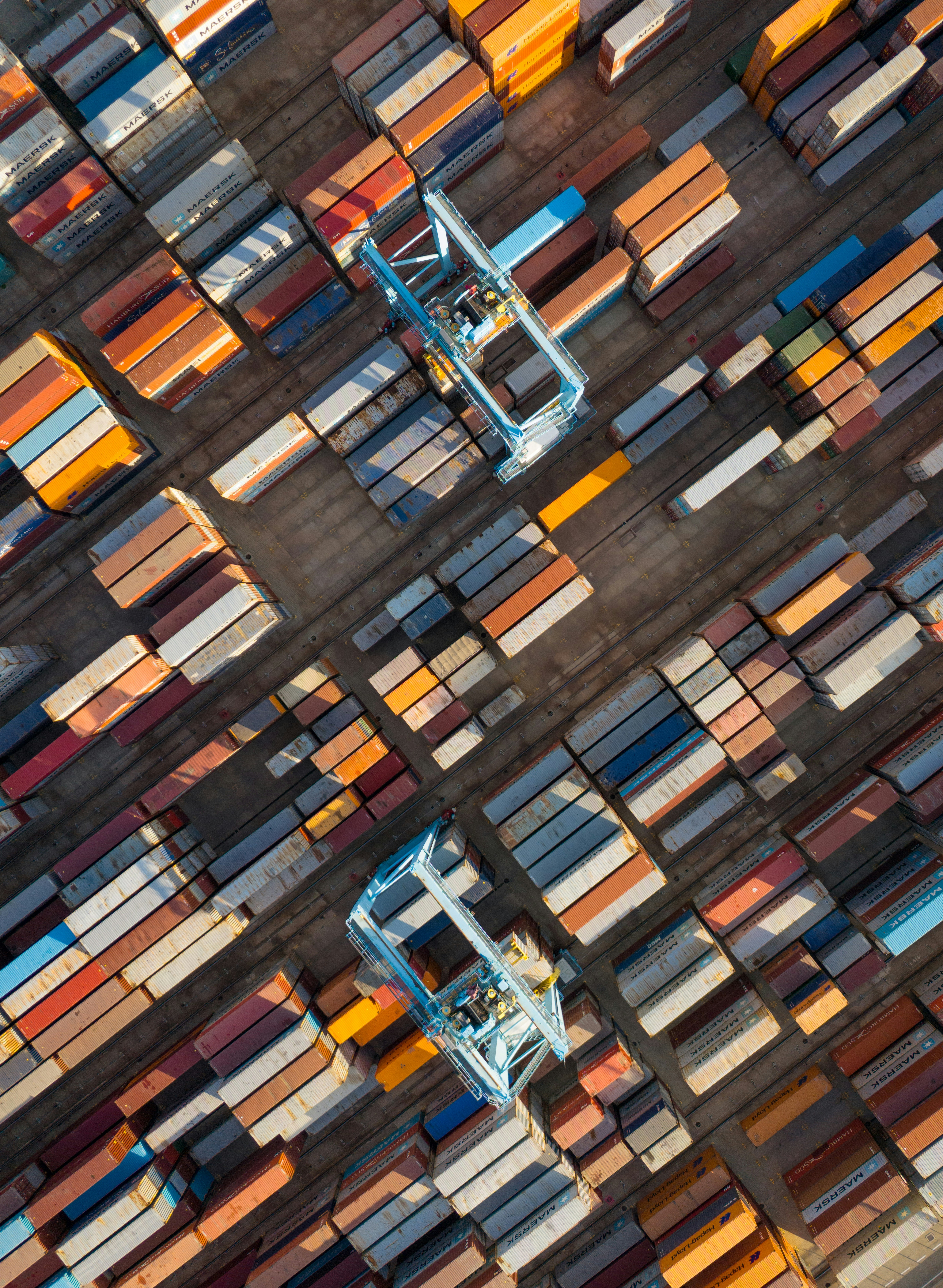Crane Deltas: Aerial Drift Among Colorful Containers