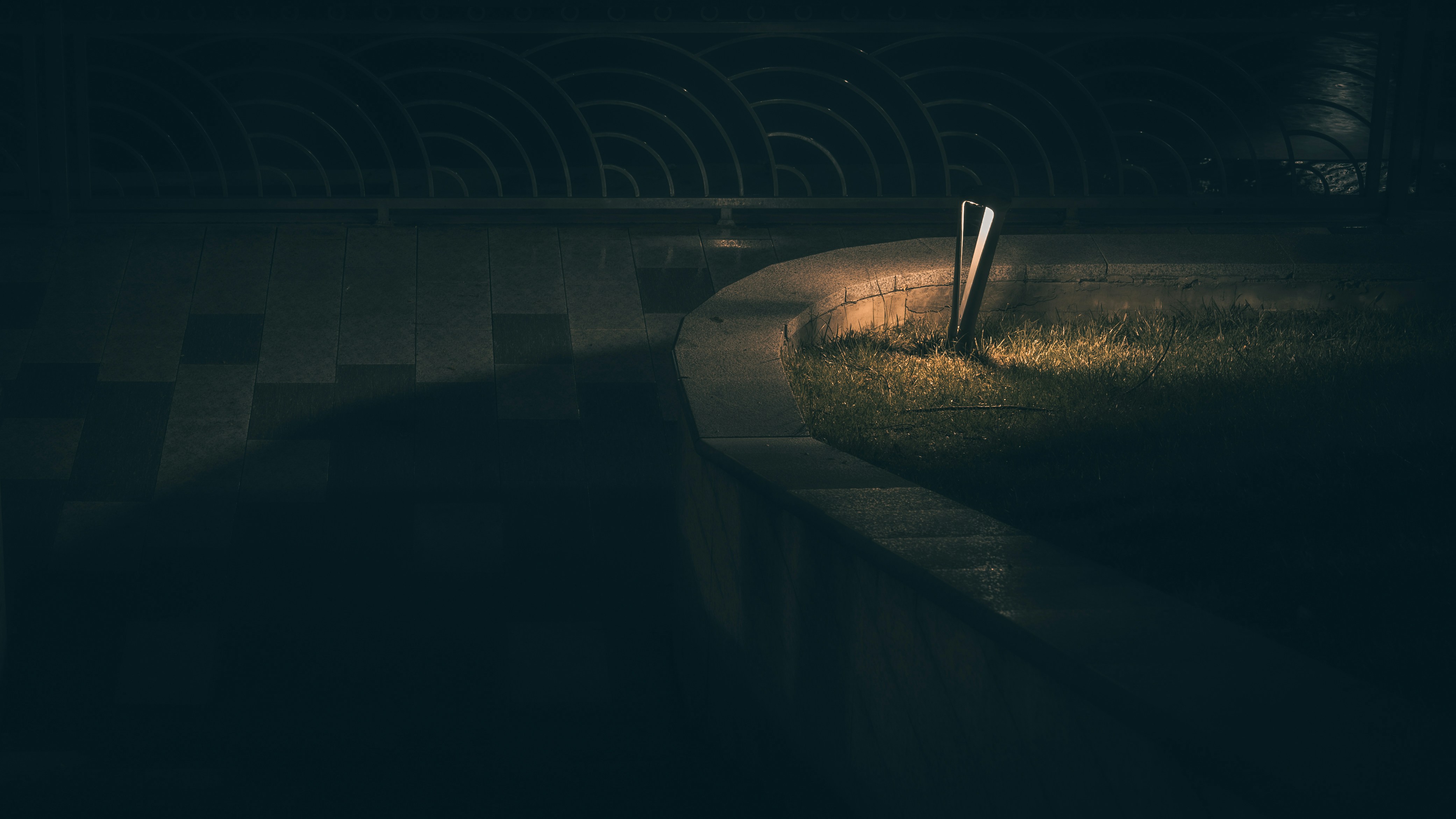 Moonlit curblight: a solitary path meets the dark pool