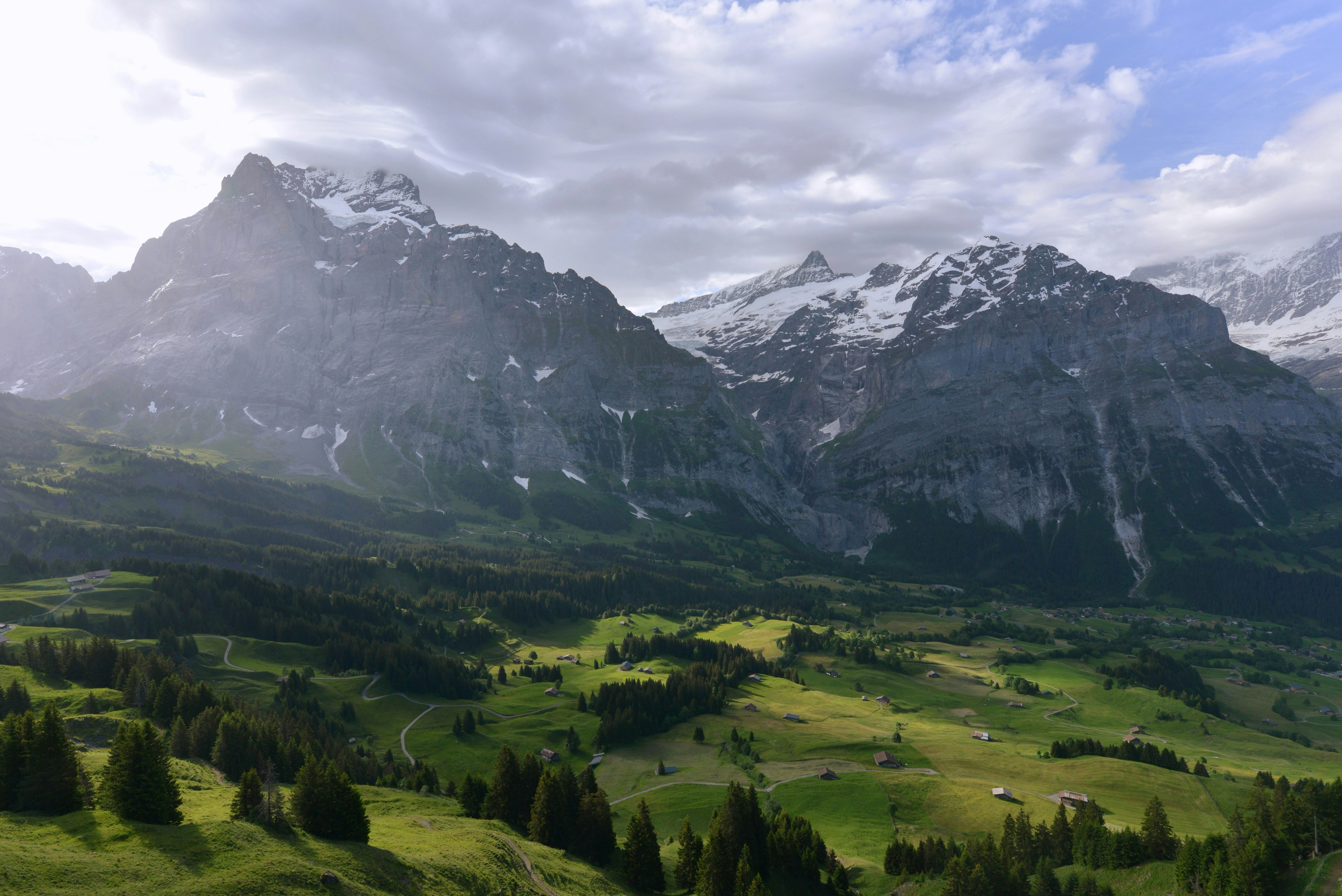 Sunlit Valley Beneath Snow-Crowned Peaks