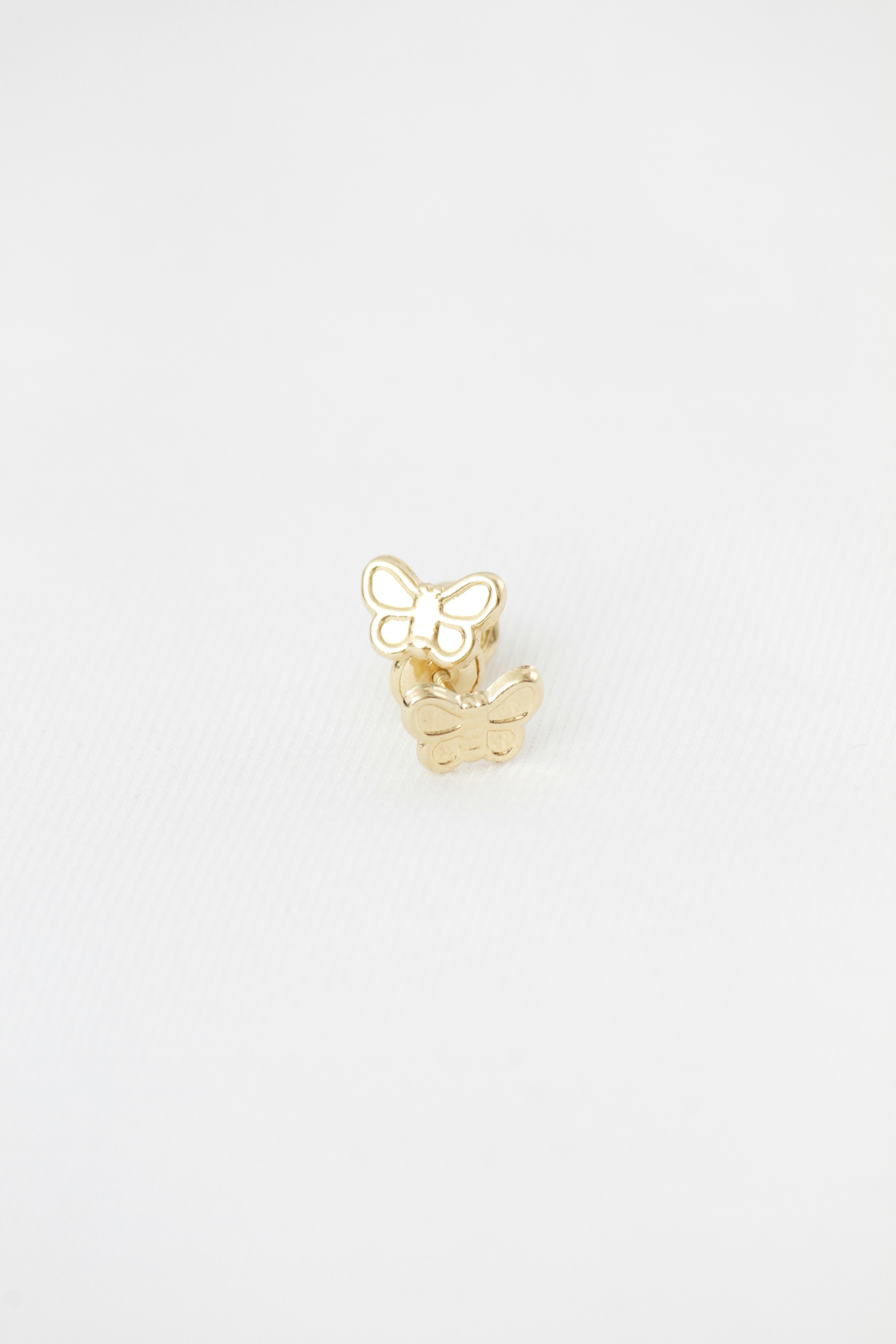 Golden Butterfly Studs: Delicate Details in White Minimalism