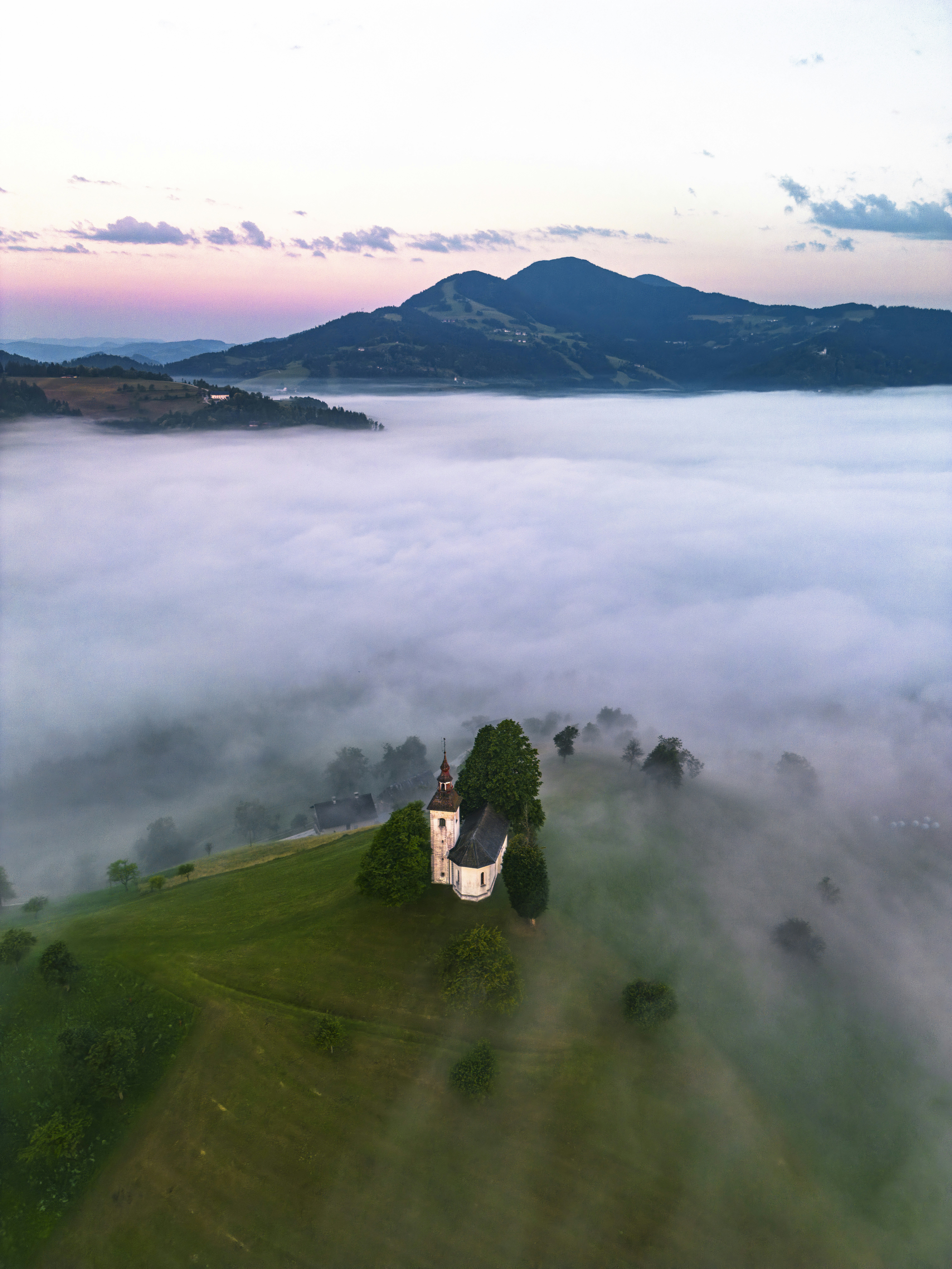 Mist-Kissed Chapel on a Cascade of Clouds
