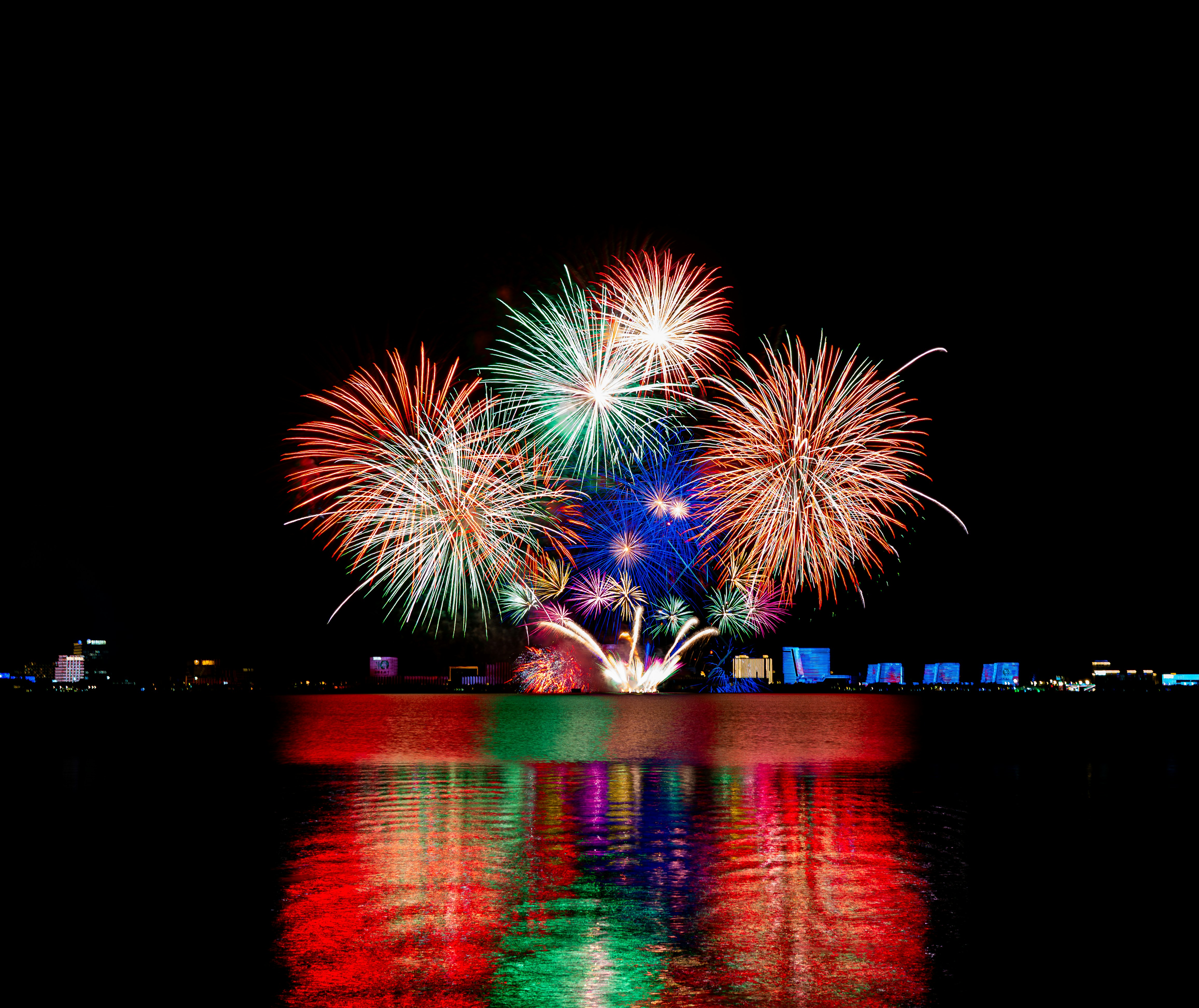 Midair Sparks Over a Glowing City Waterfront