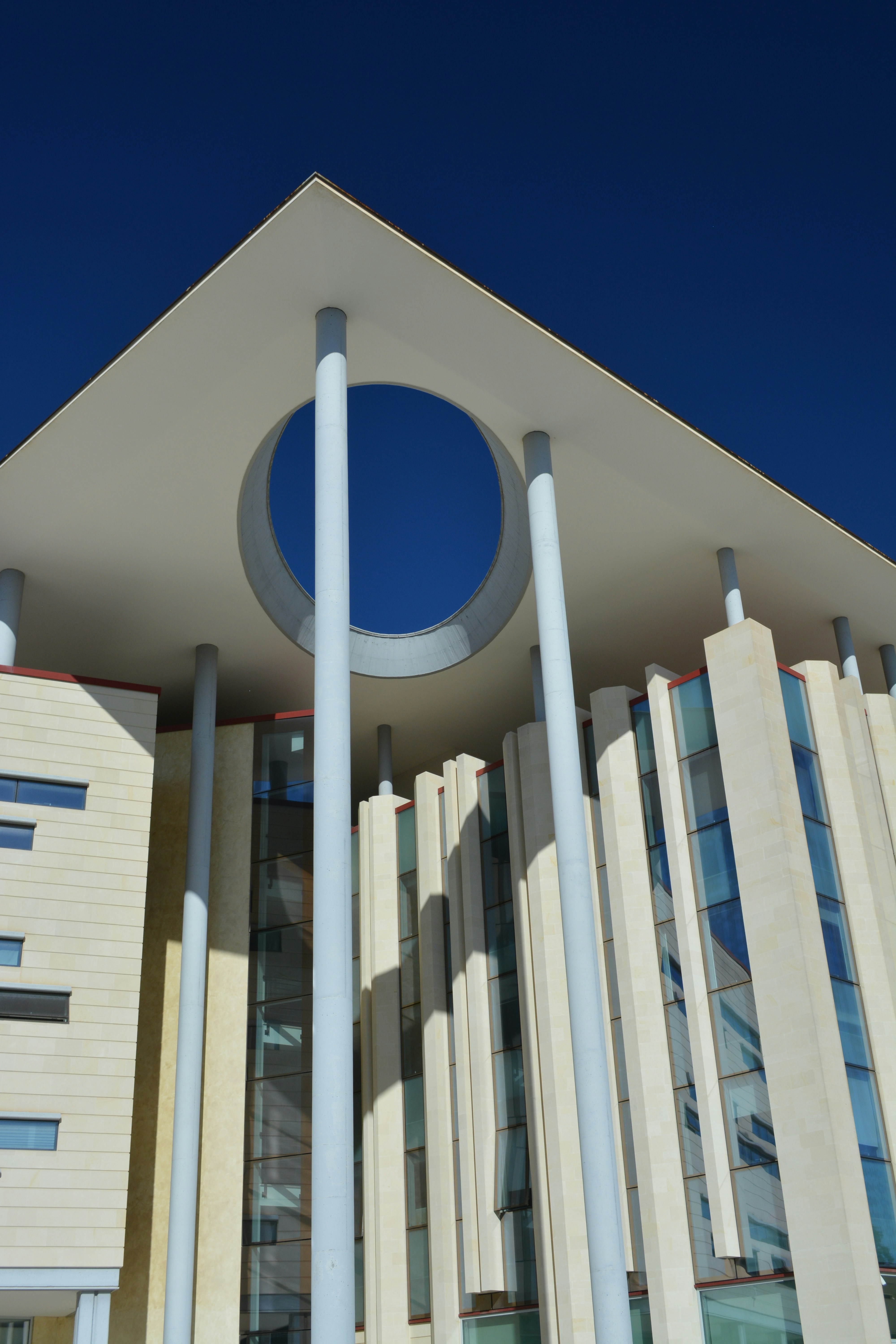 Architectural Ring: A Modern Facade Crowned by Circular Opening
