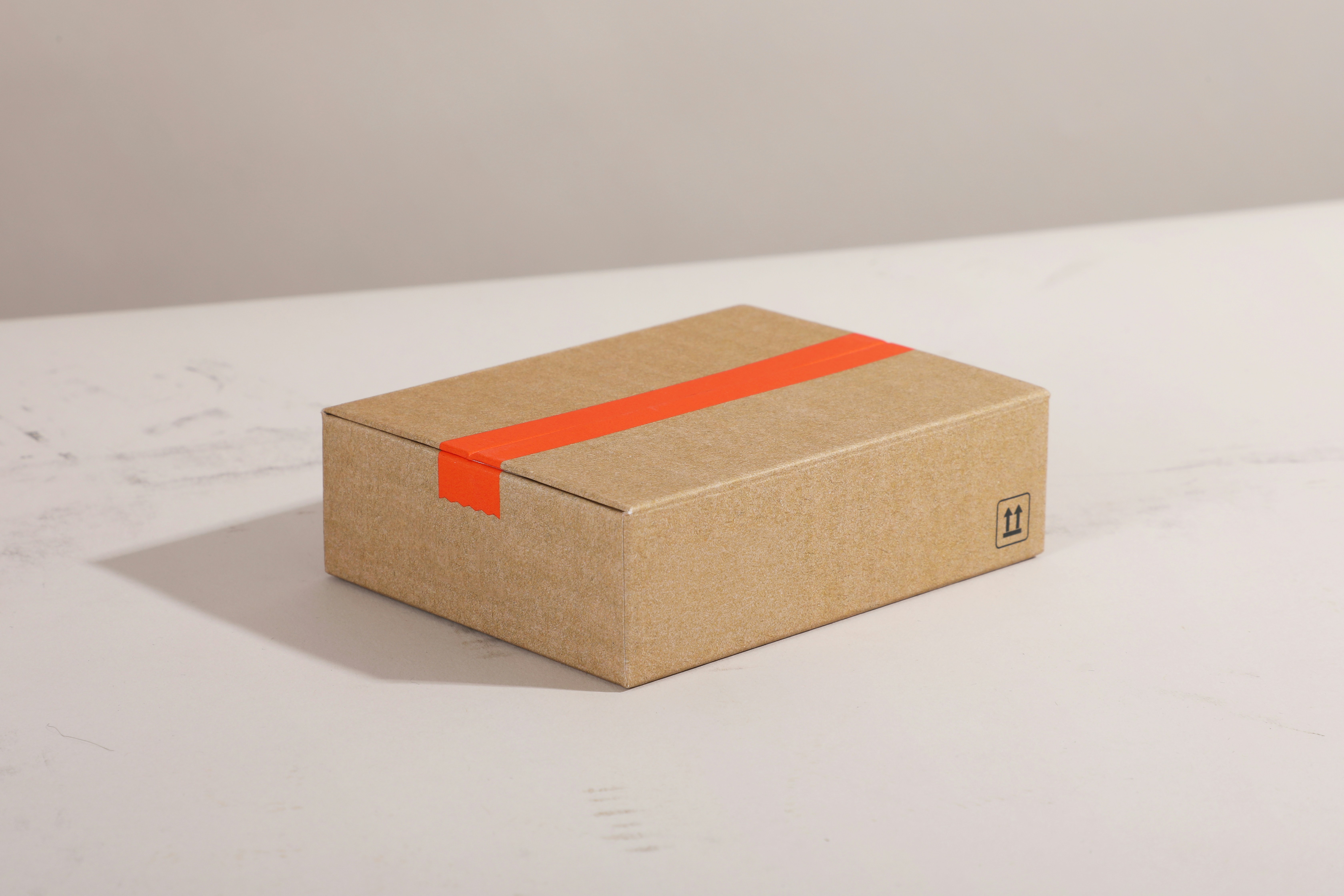 Red-Taped Parcel: A Simple Box on a Quiet Studio Surface
