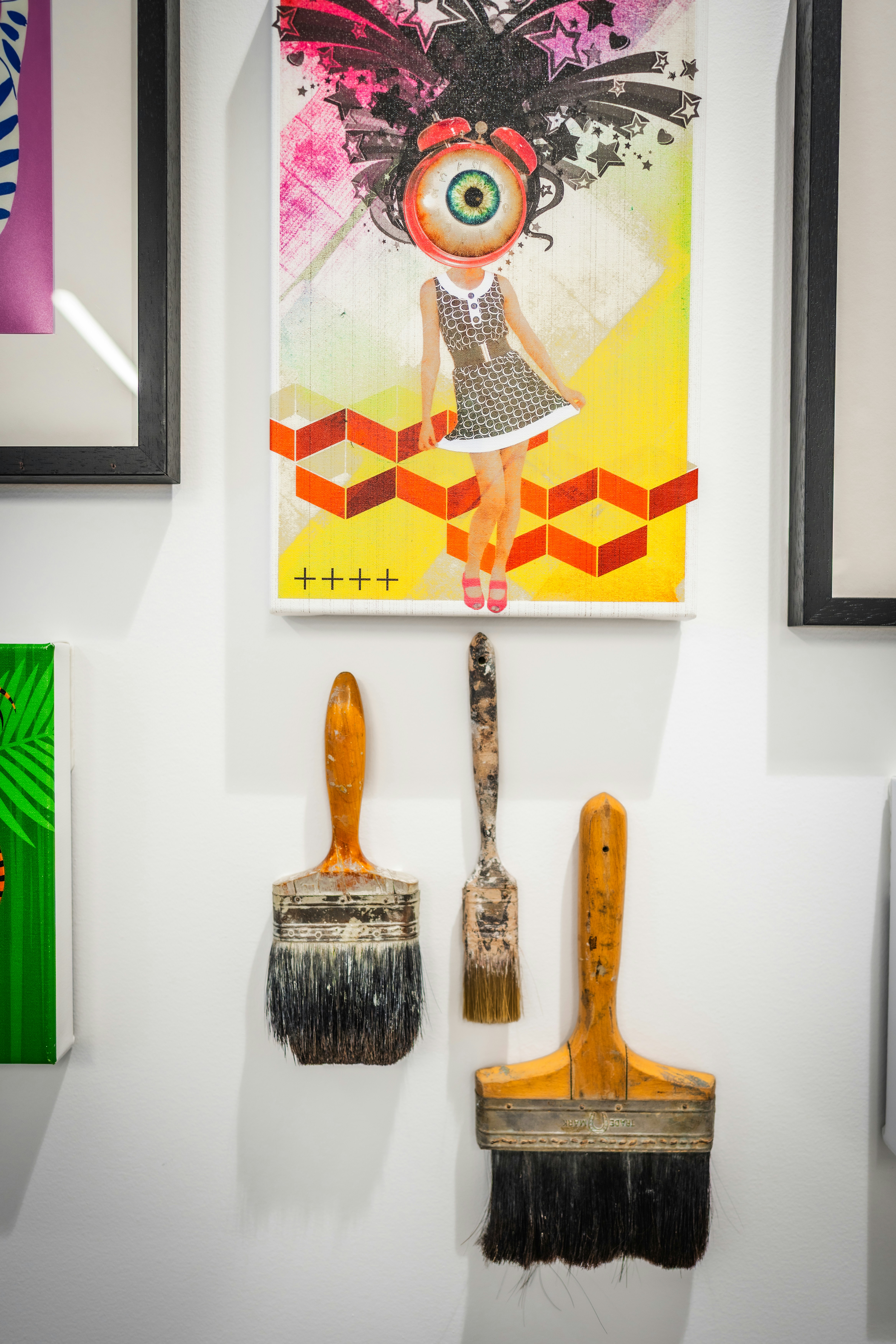 Eye of a Surreal Gallery: Tools and Portraits on a White Wall