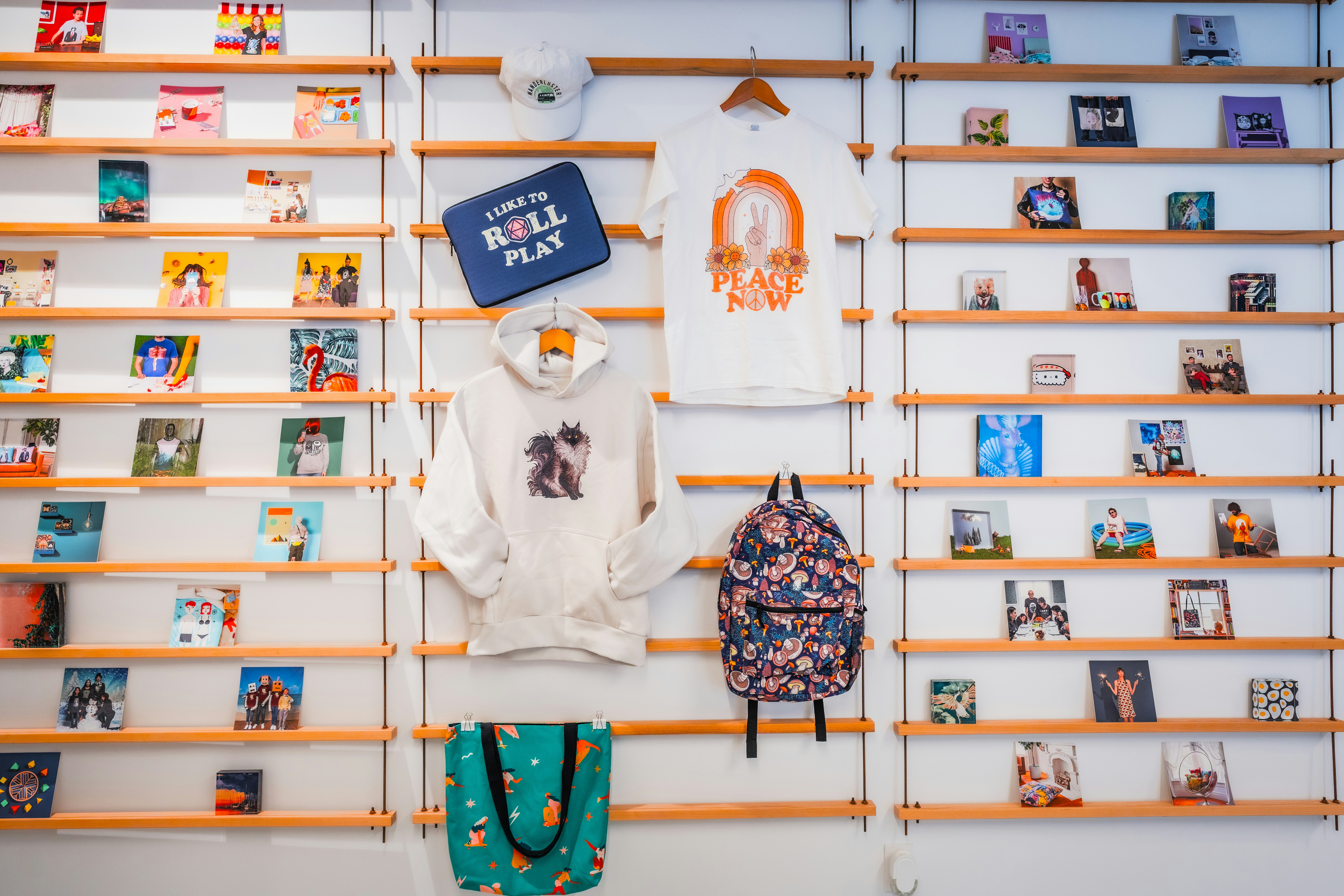 Wall of Whimsy: Storefront Shelves with Tees, Backpacks, and Mini Prints
