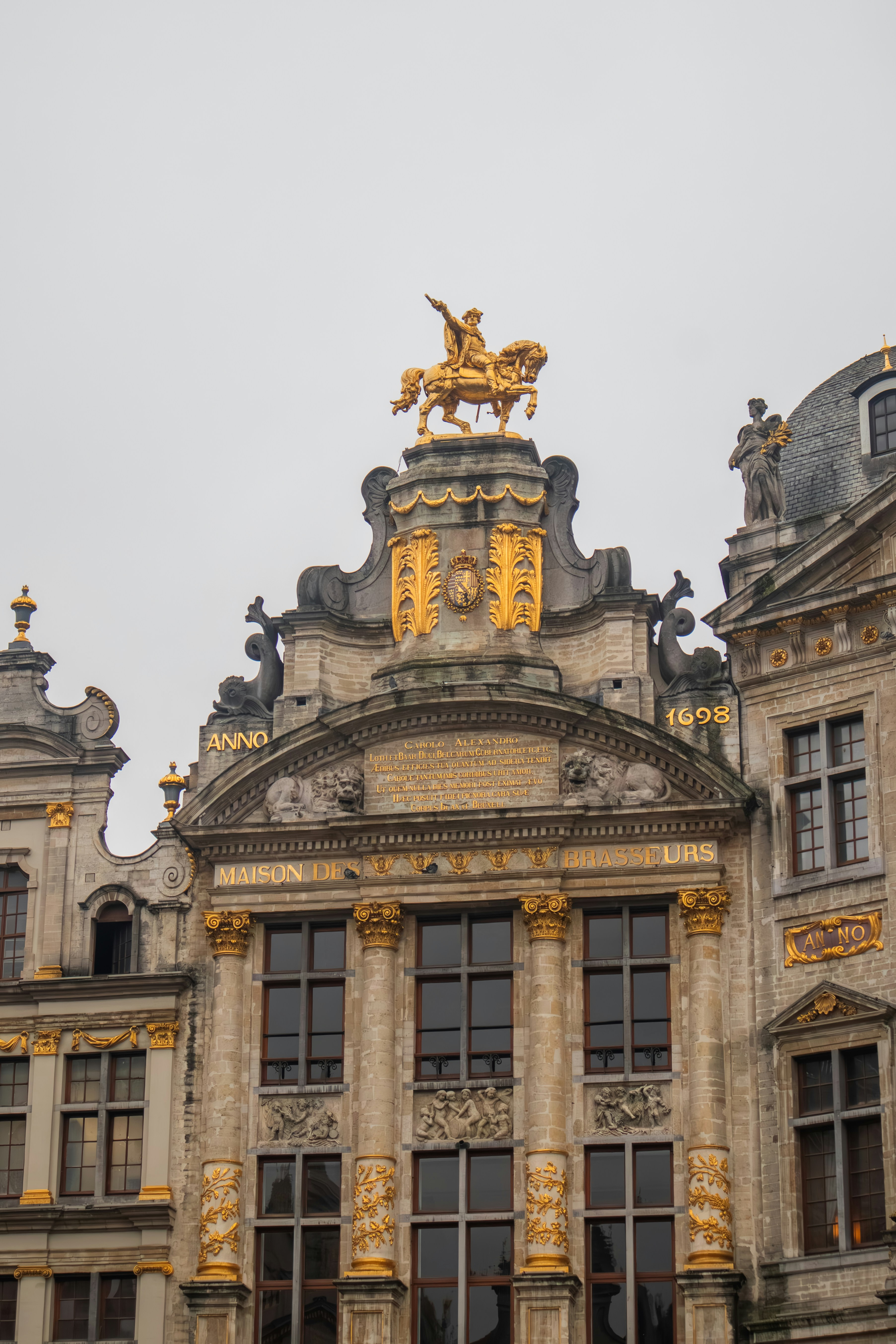 Golden Equine Crest: The Equestrian Statues Crown a Historic Facade