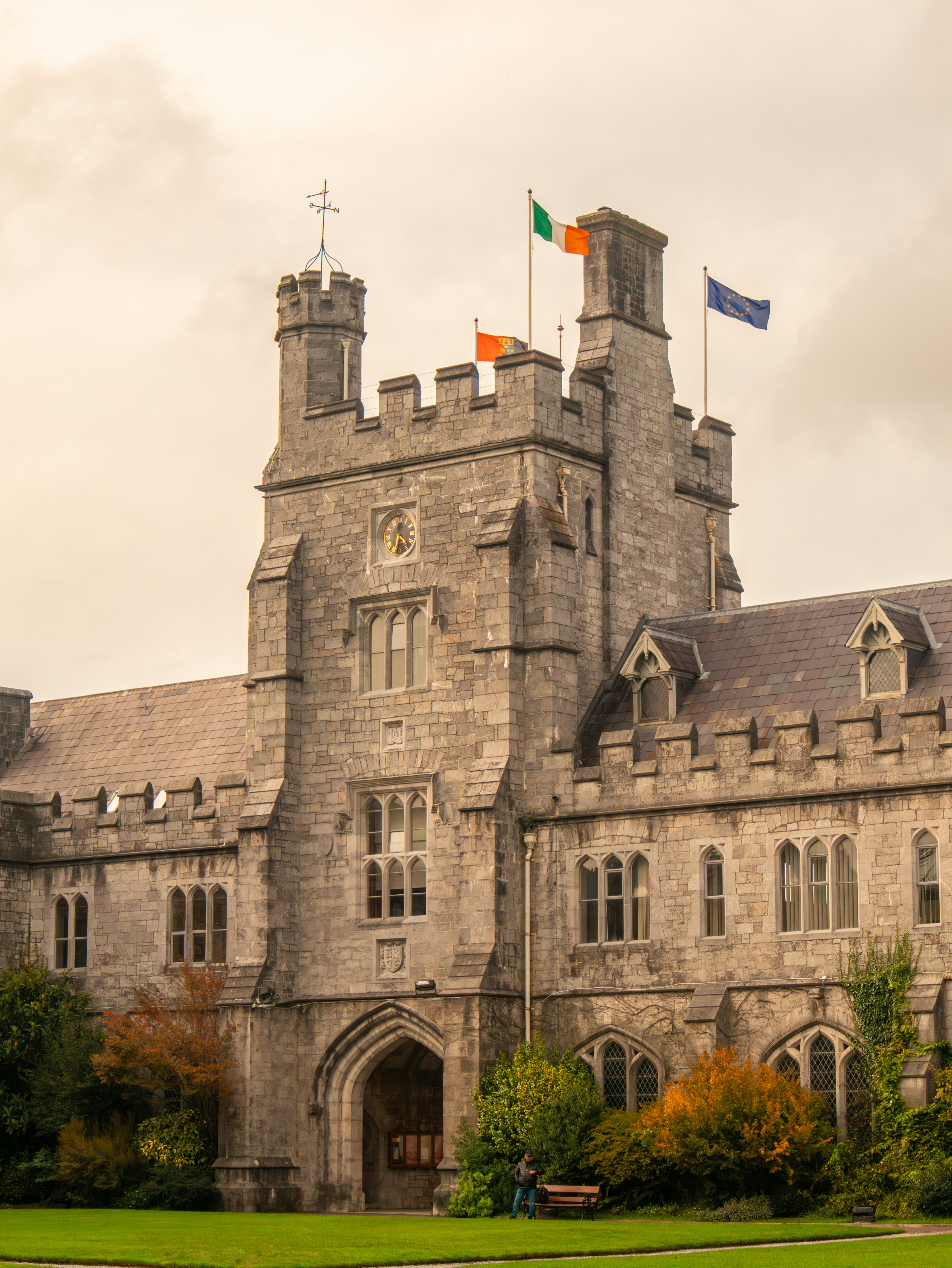 Castle Gatehouse Crowned with Flags under a Cloudy Sky
