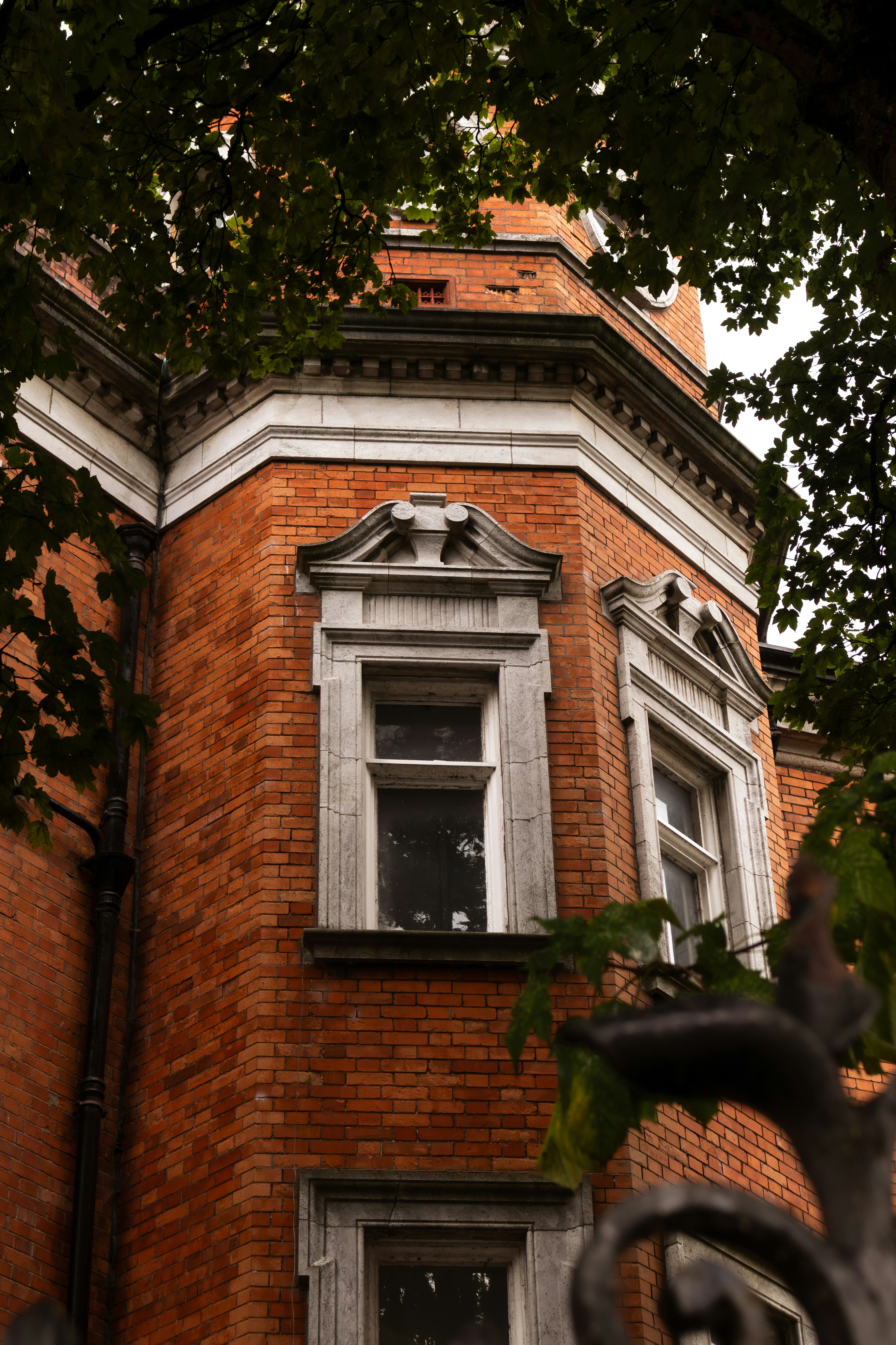 Brick Cornerstone: Ornate Window Details on a Red Brick Terrace