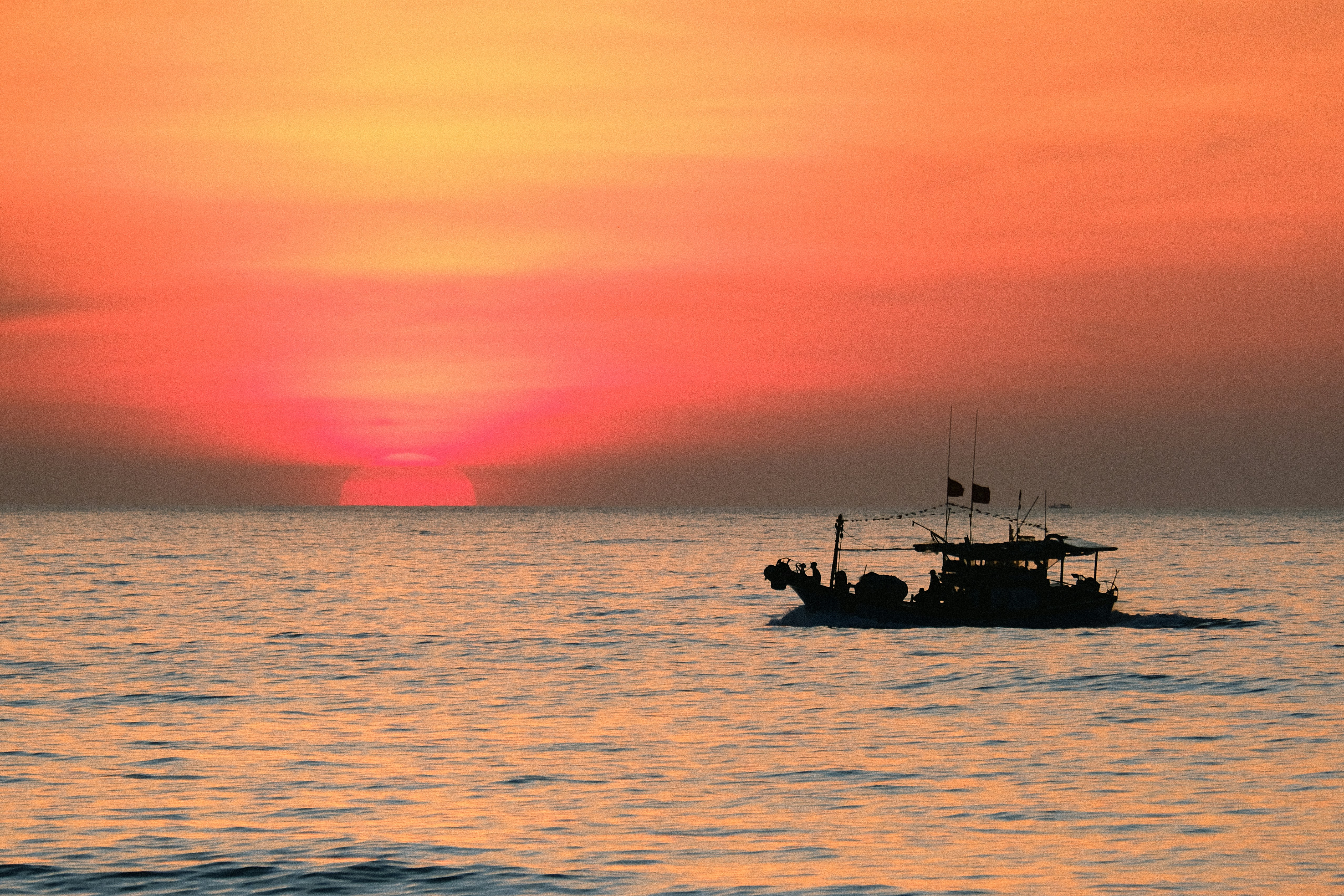 Sunset Freighter: A Quiet Horizon and the silhouetted vessel