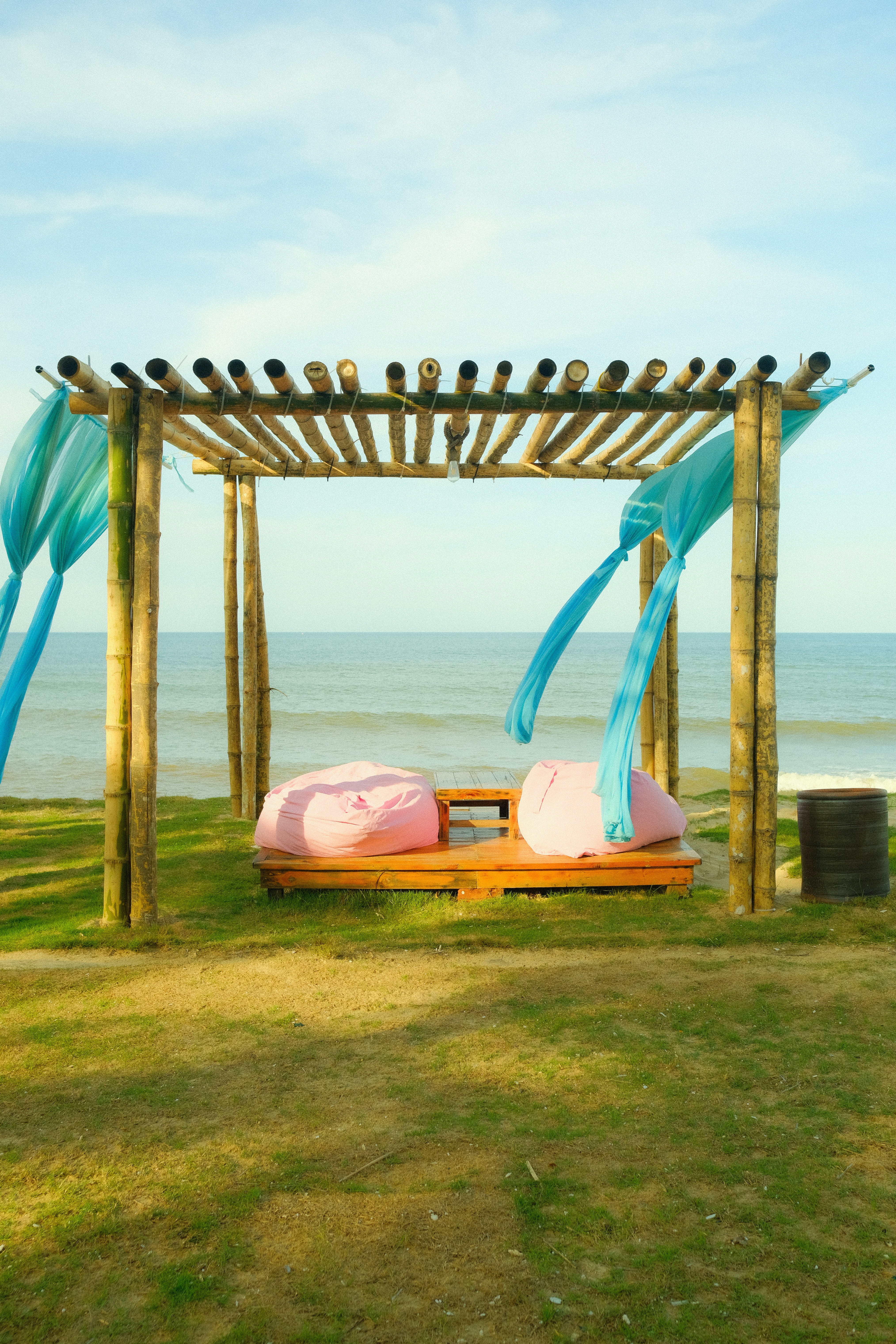 Beach Oasis Pergola with Cotton-Candy Seating under Turquoise Drapes