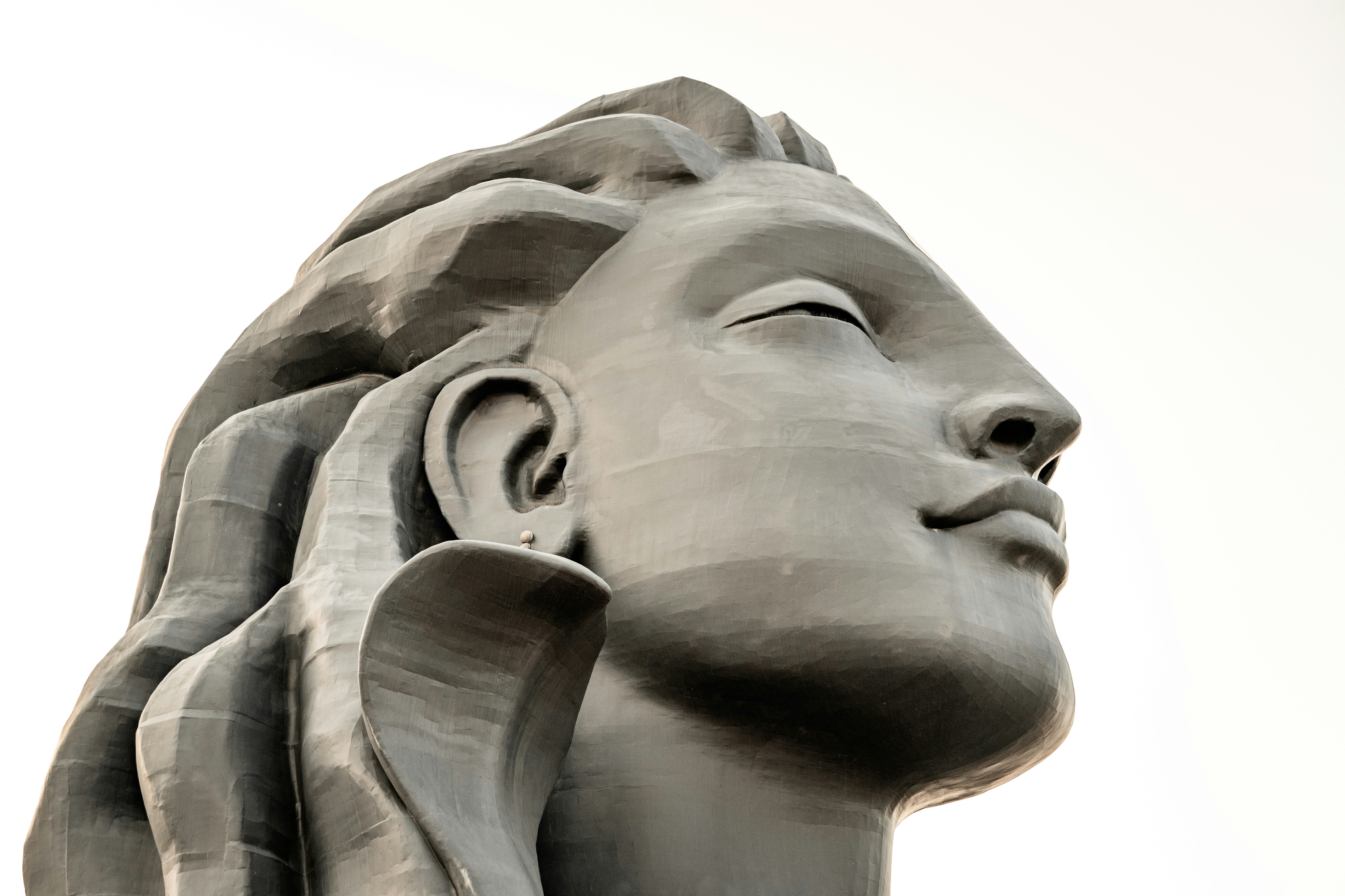Elevated Resolve: A Solitary Statue Gazing Toward the Light