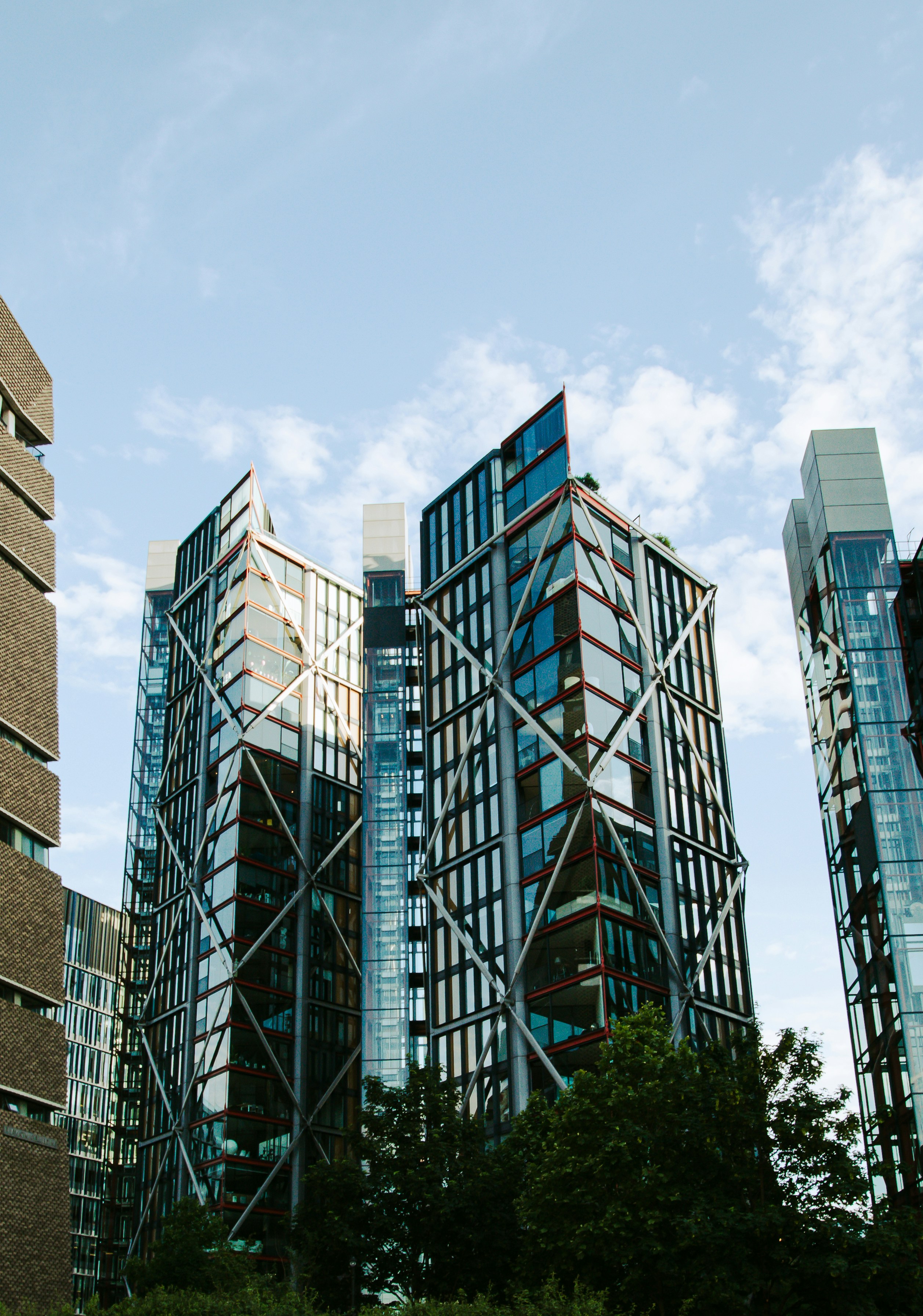 Diagonal Facades Rise: A Cluster of Glassy Towers Framed Against a Sky