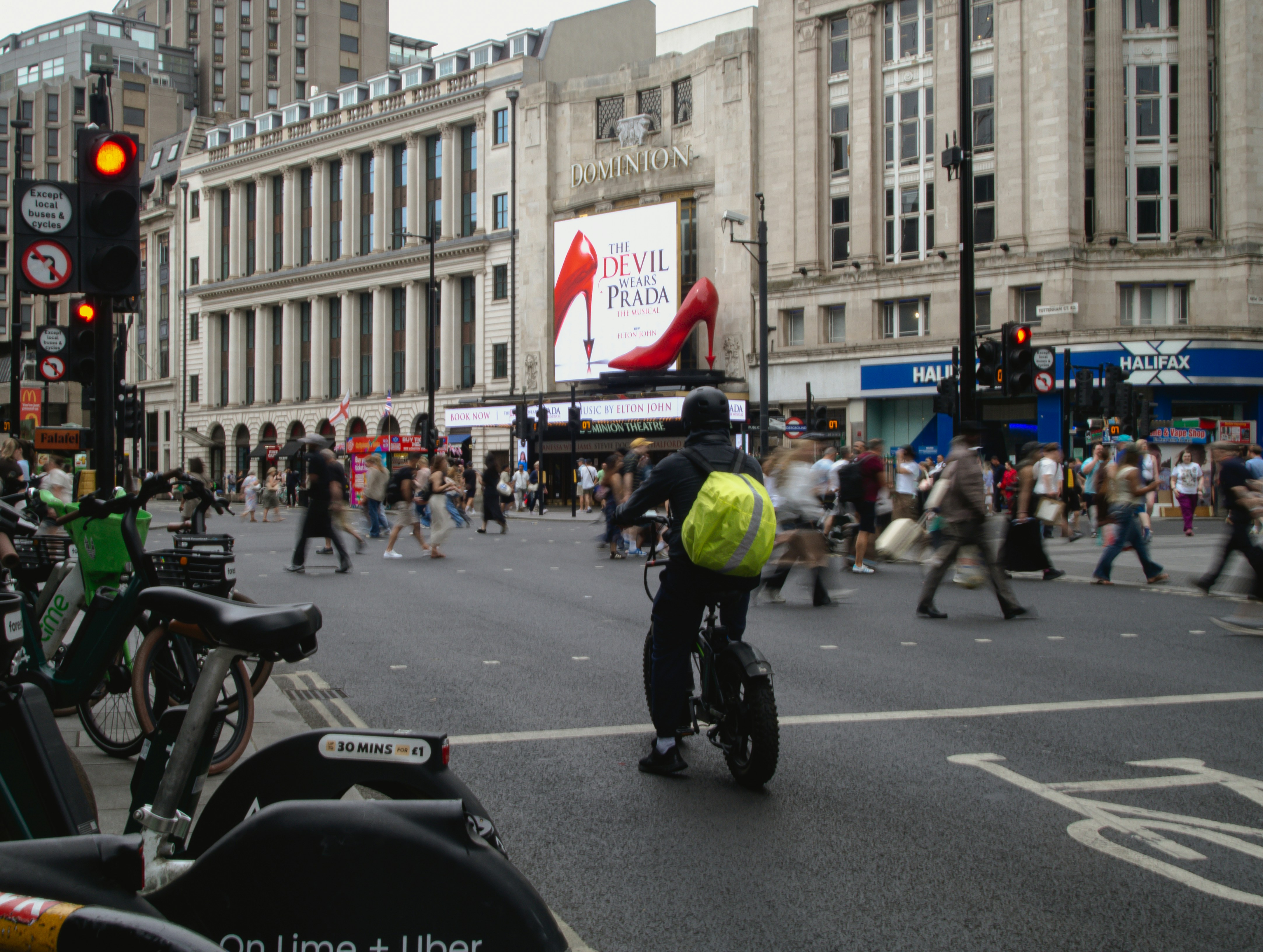 Urban Balance: Cyclist at a Busy City Crossing