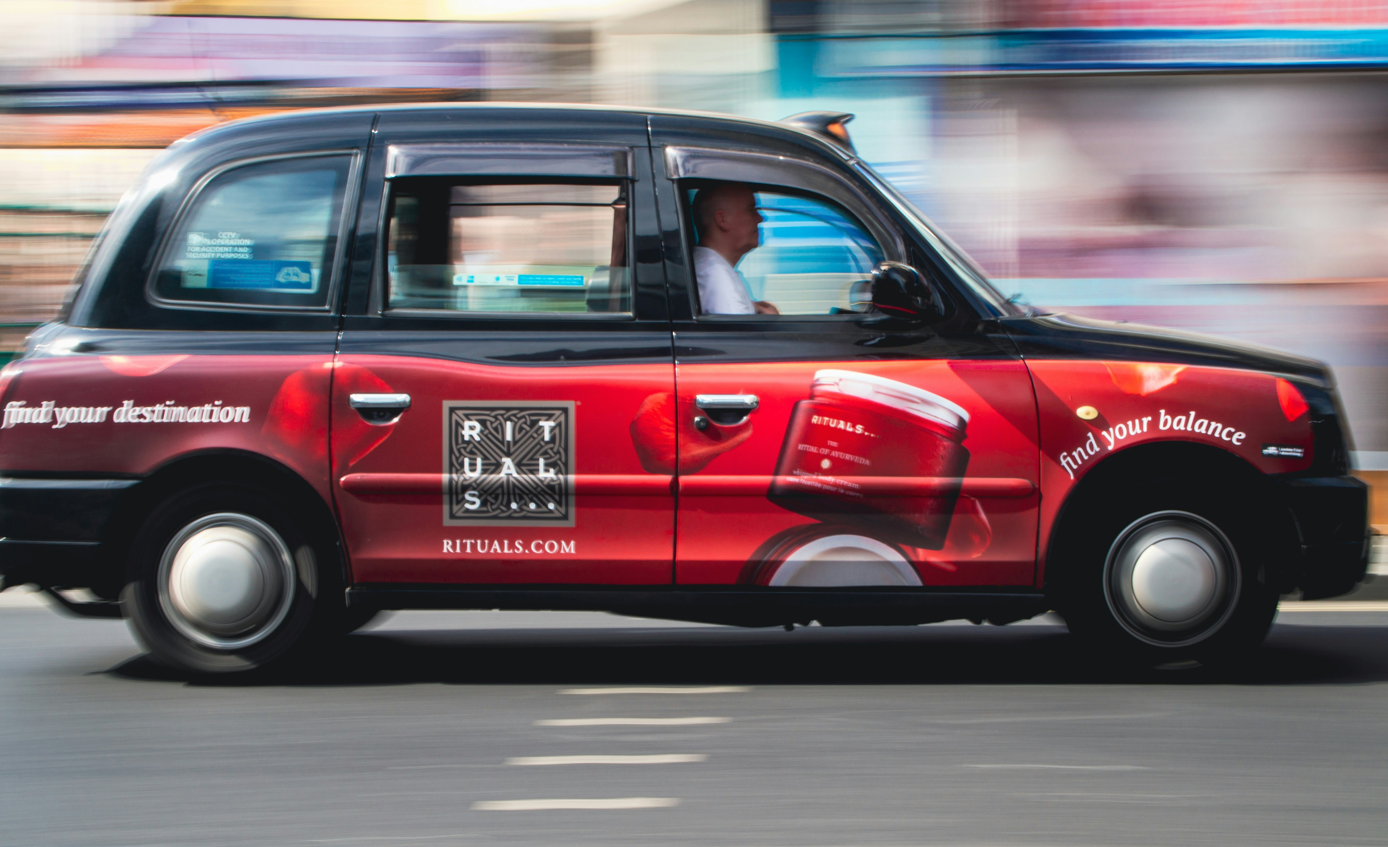 Red London Taxi in Motion: Branding in a Blur of City Light