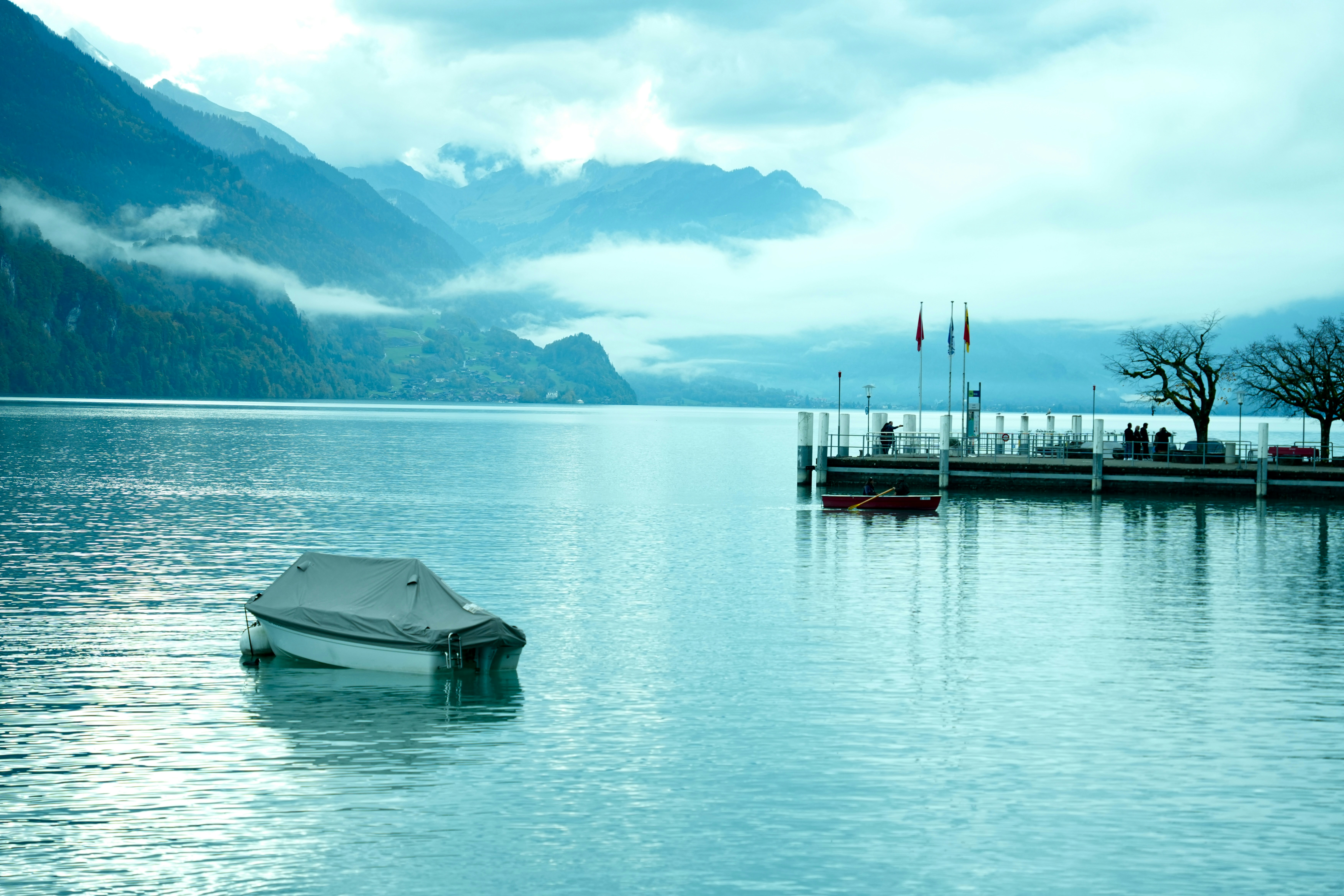 Boat at Rest on a Misty Lake Beneath Alpine Peaks
