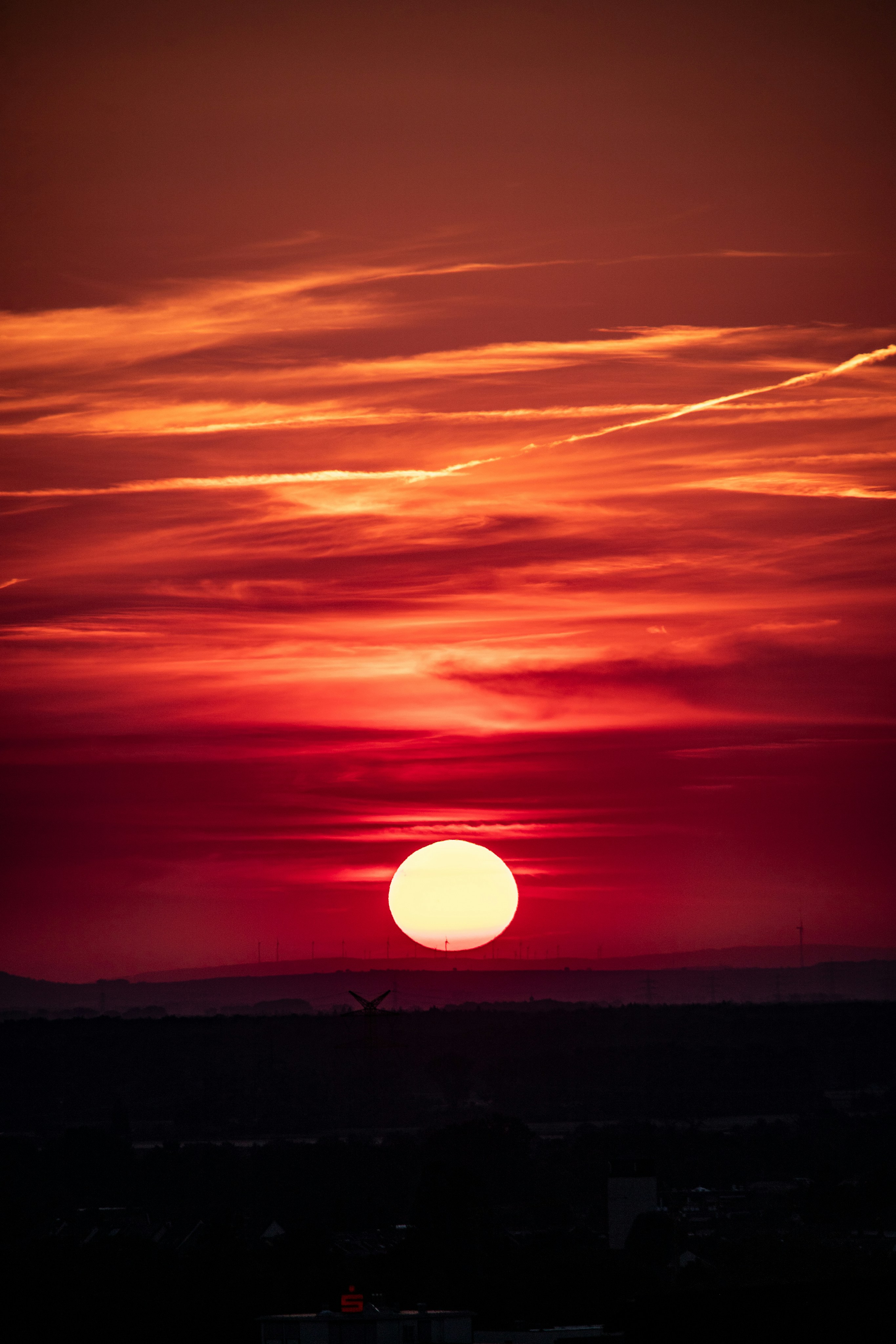 Crimson Horizon: A Blood-Orange Sunset Over Quiet Flats