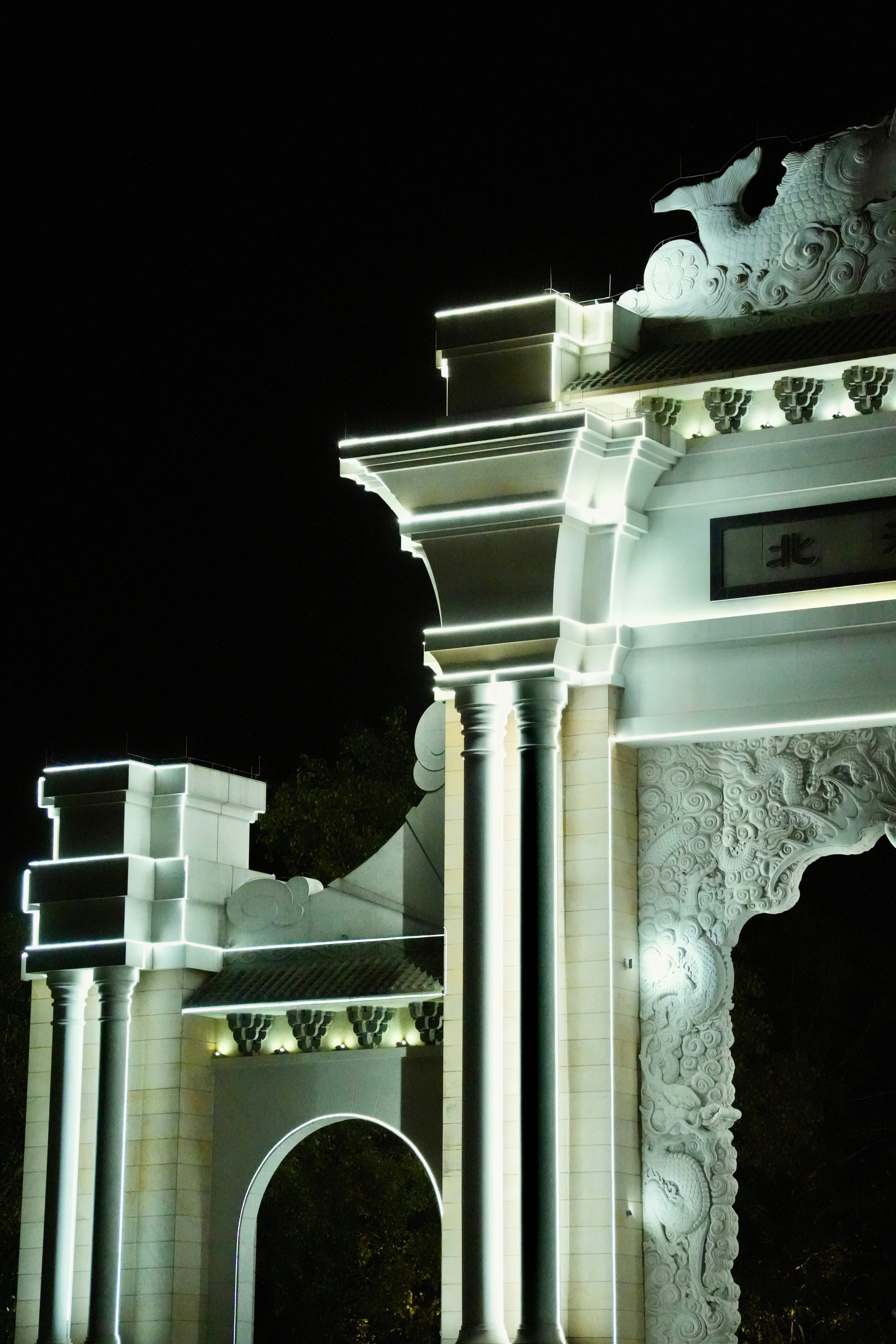 Moonlit Gatekeepers: Illuminated Dragon Arch at a Night Crossing