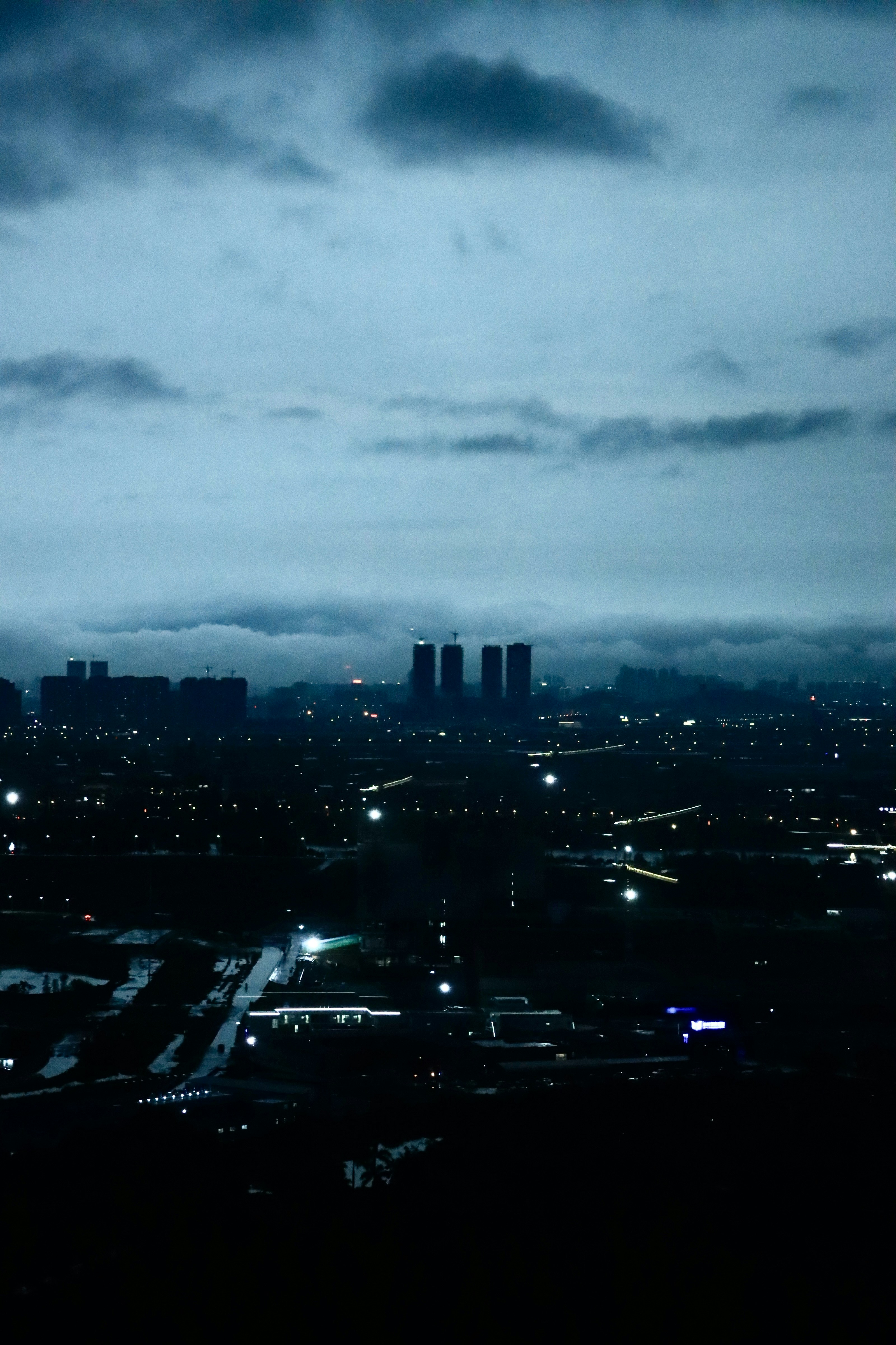 Midnight Skyline: A Quiet City Beneath Low Clouds