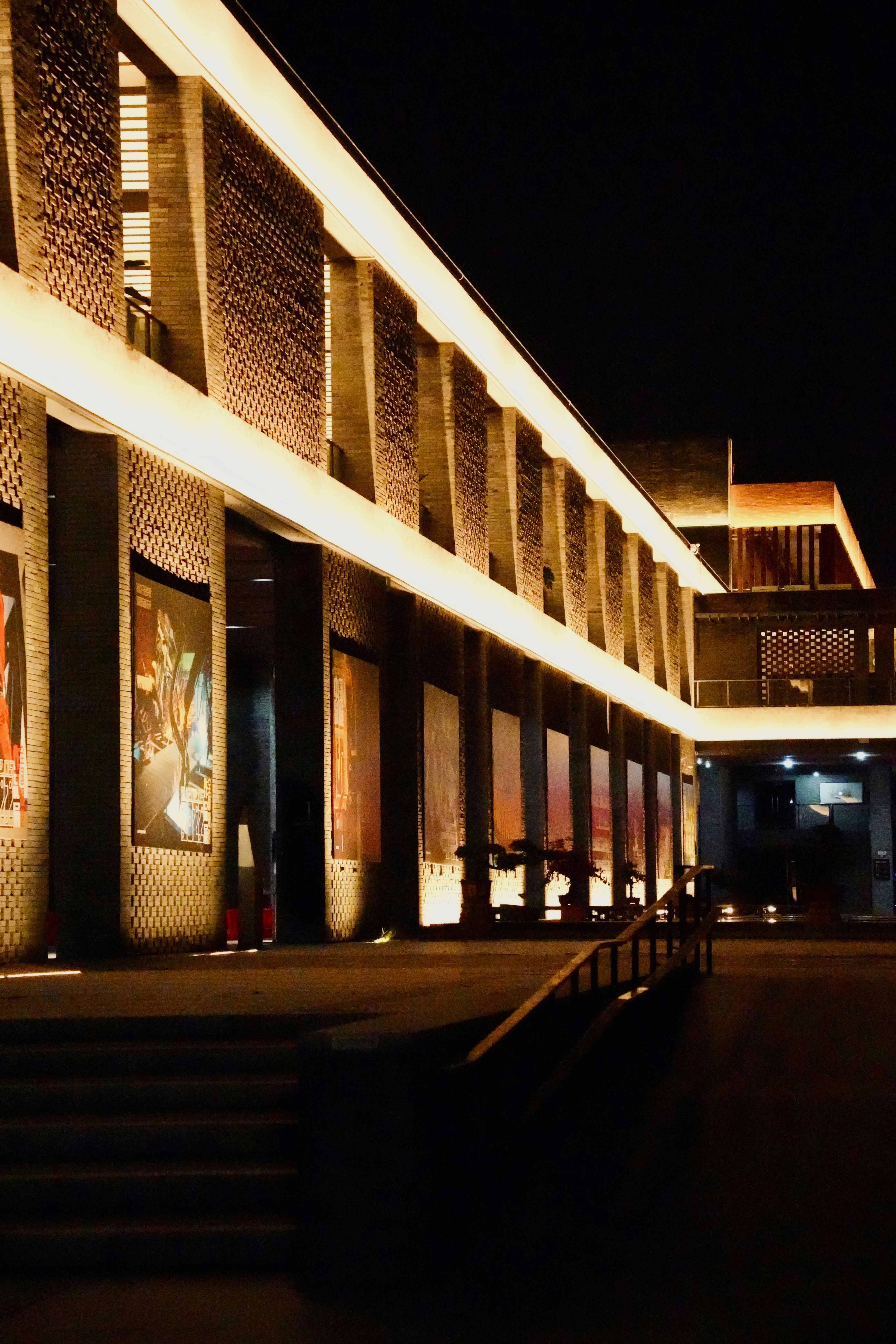 Night Facade: Warm Lines and Silent Steps along an Illuminated Terrace