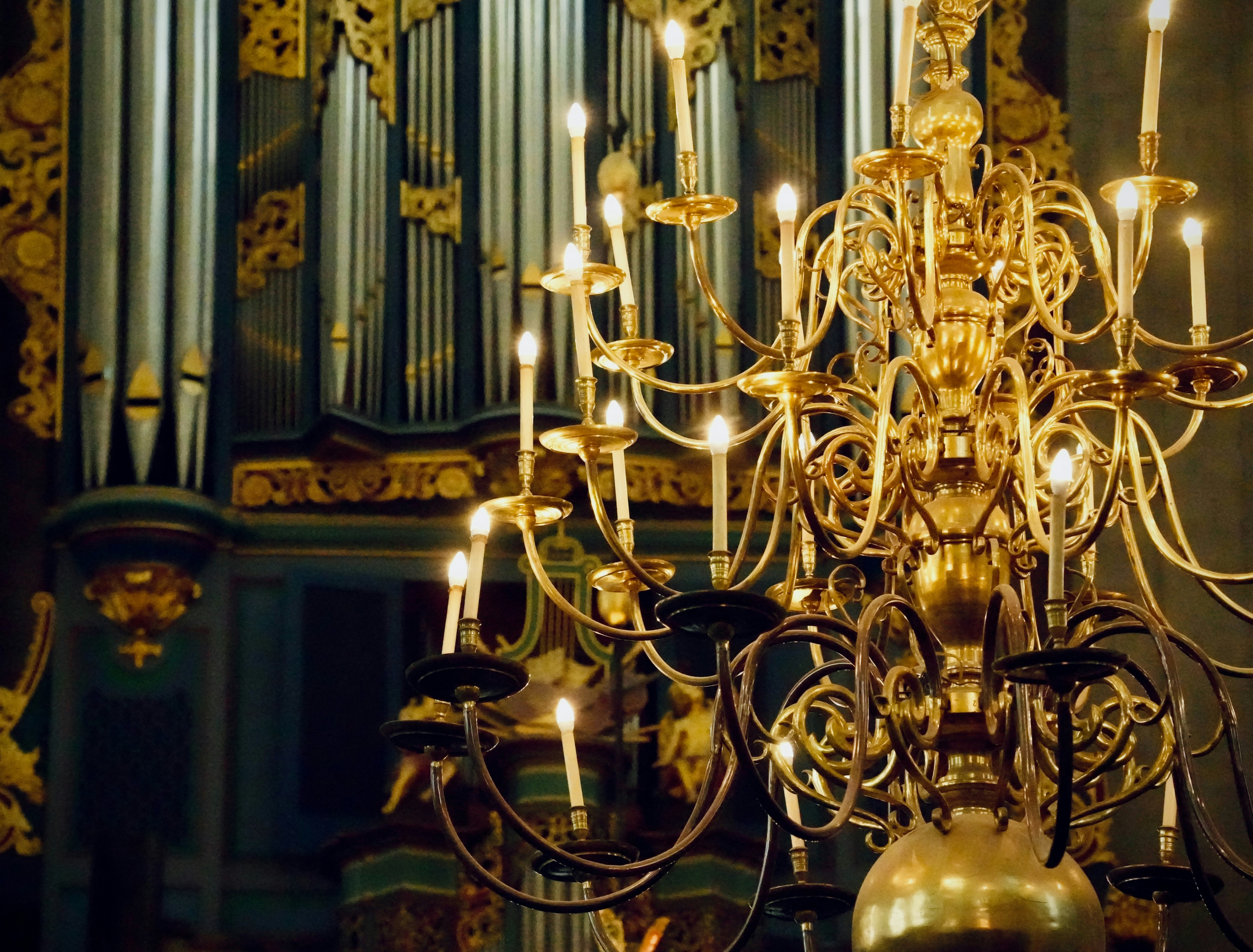 Gilded Radiance: An Imperial Chandelier Adorned with Candlelight