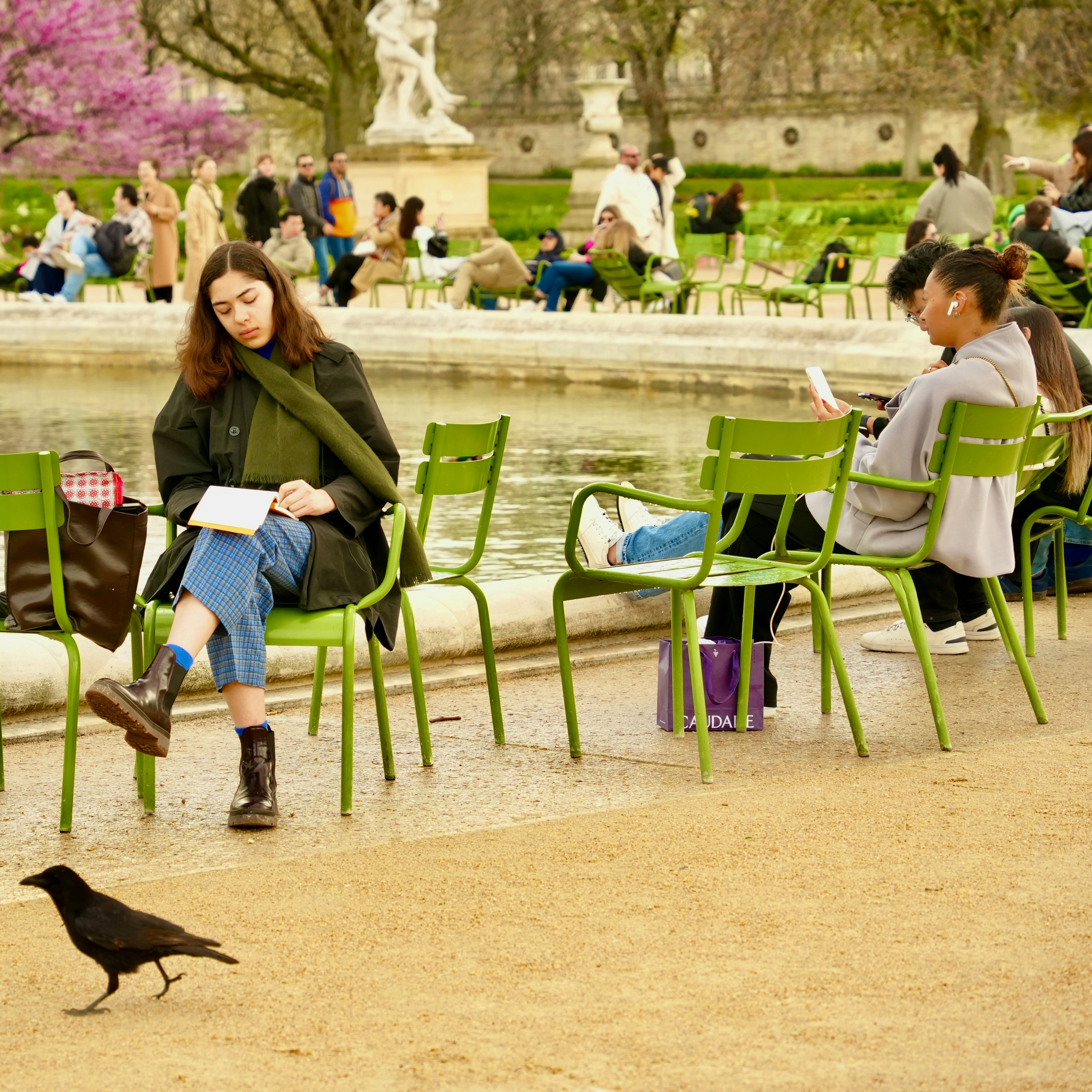 Quiet Afternoon: A Woman Reads Amid Green Chairs by a Pond