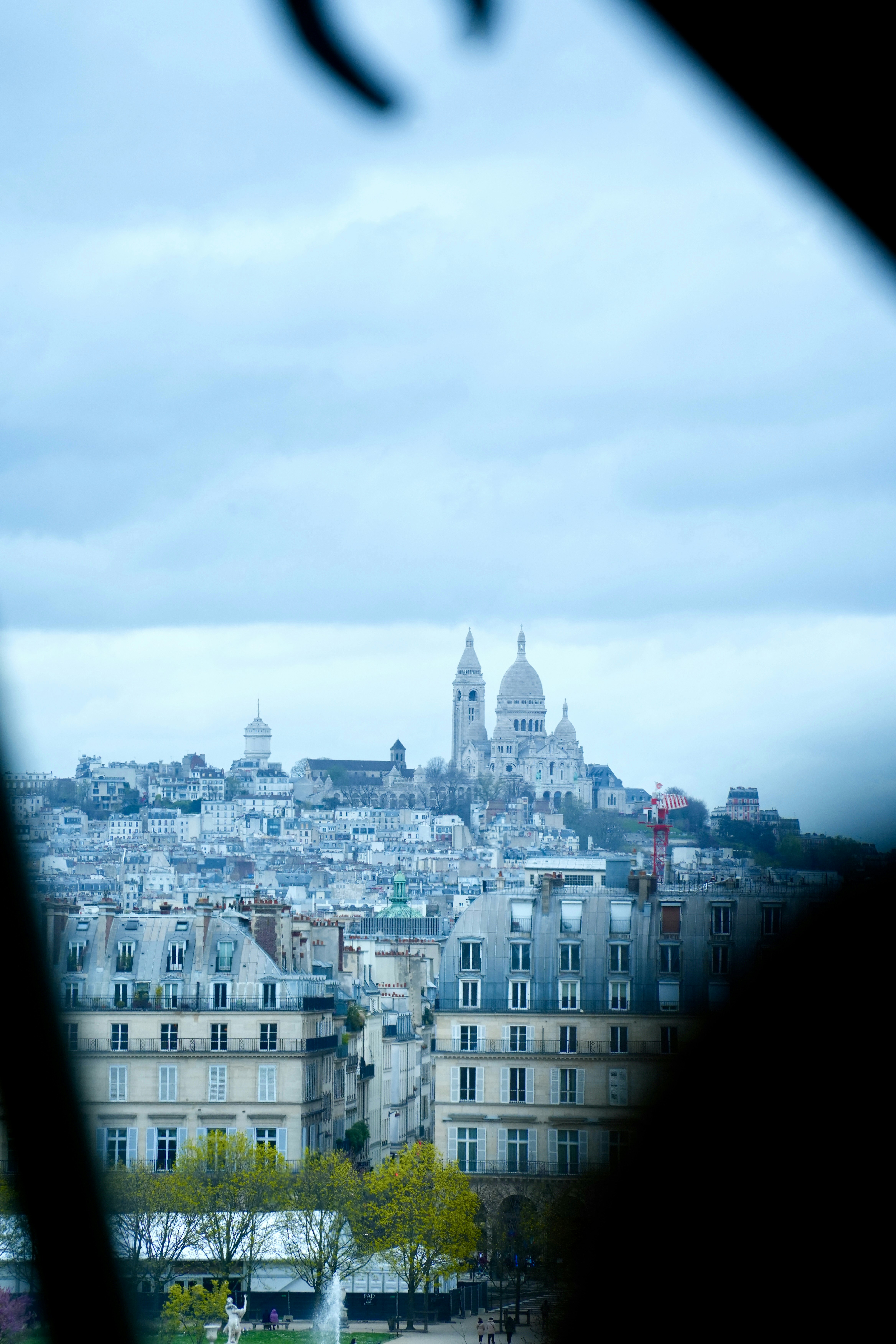 Cityscape Framed by Iconic Dome: A Citadel Hushed by Clouds