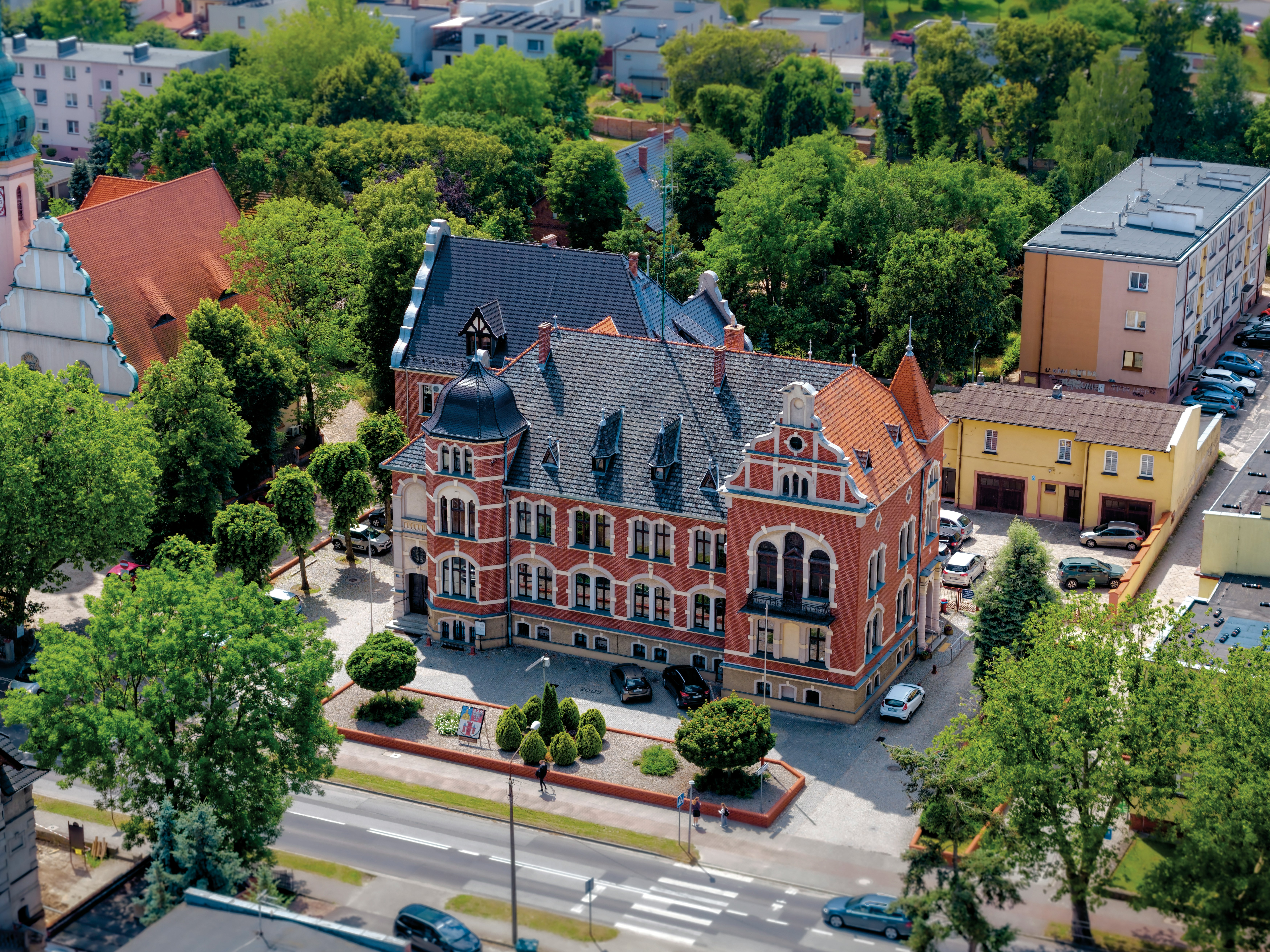 Red-brick Swiss-style Town Hall in a sunlit neighborhood