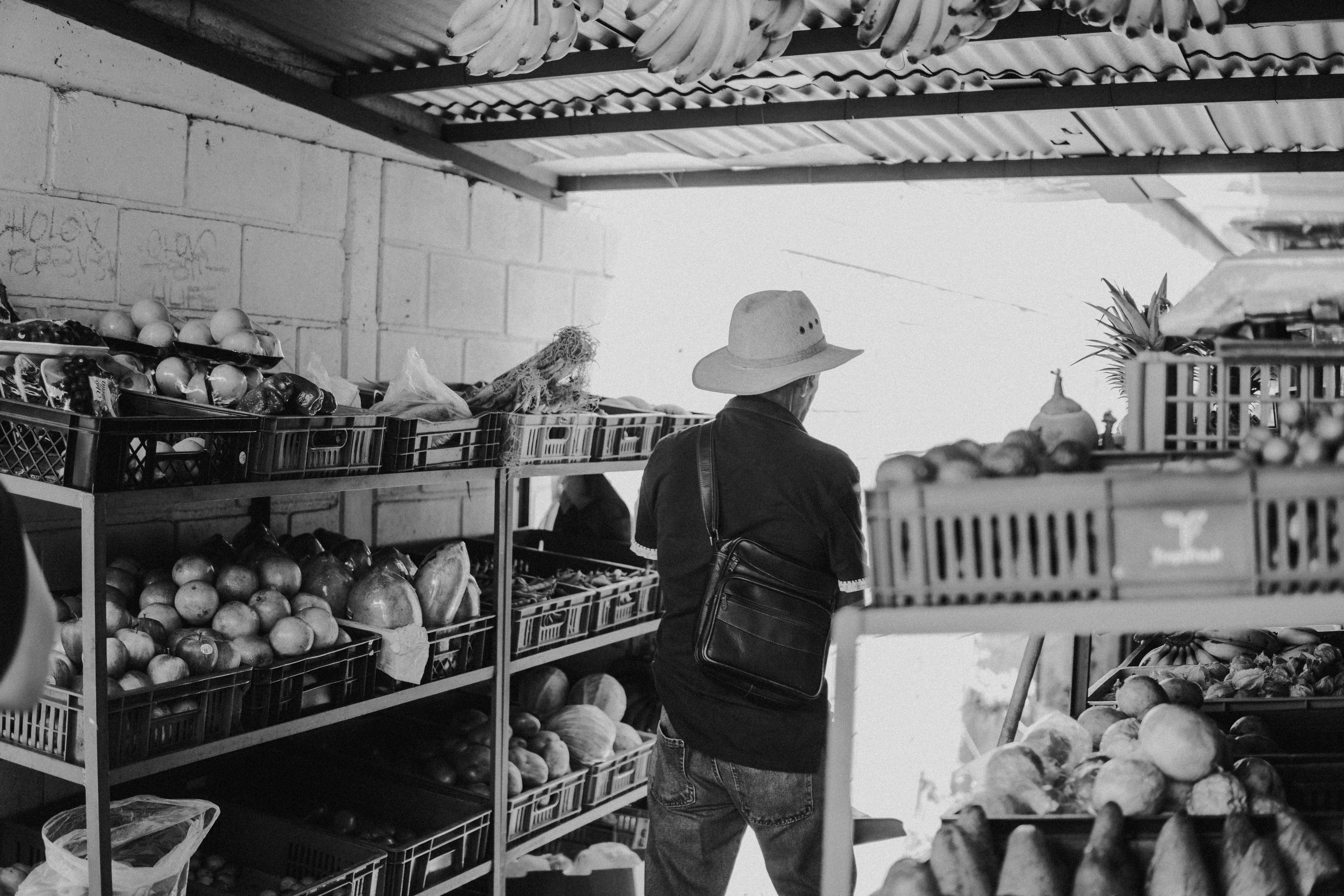 Market Walk: A Quiet Moment Among Stacked Produce