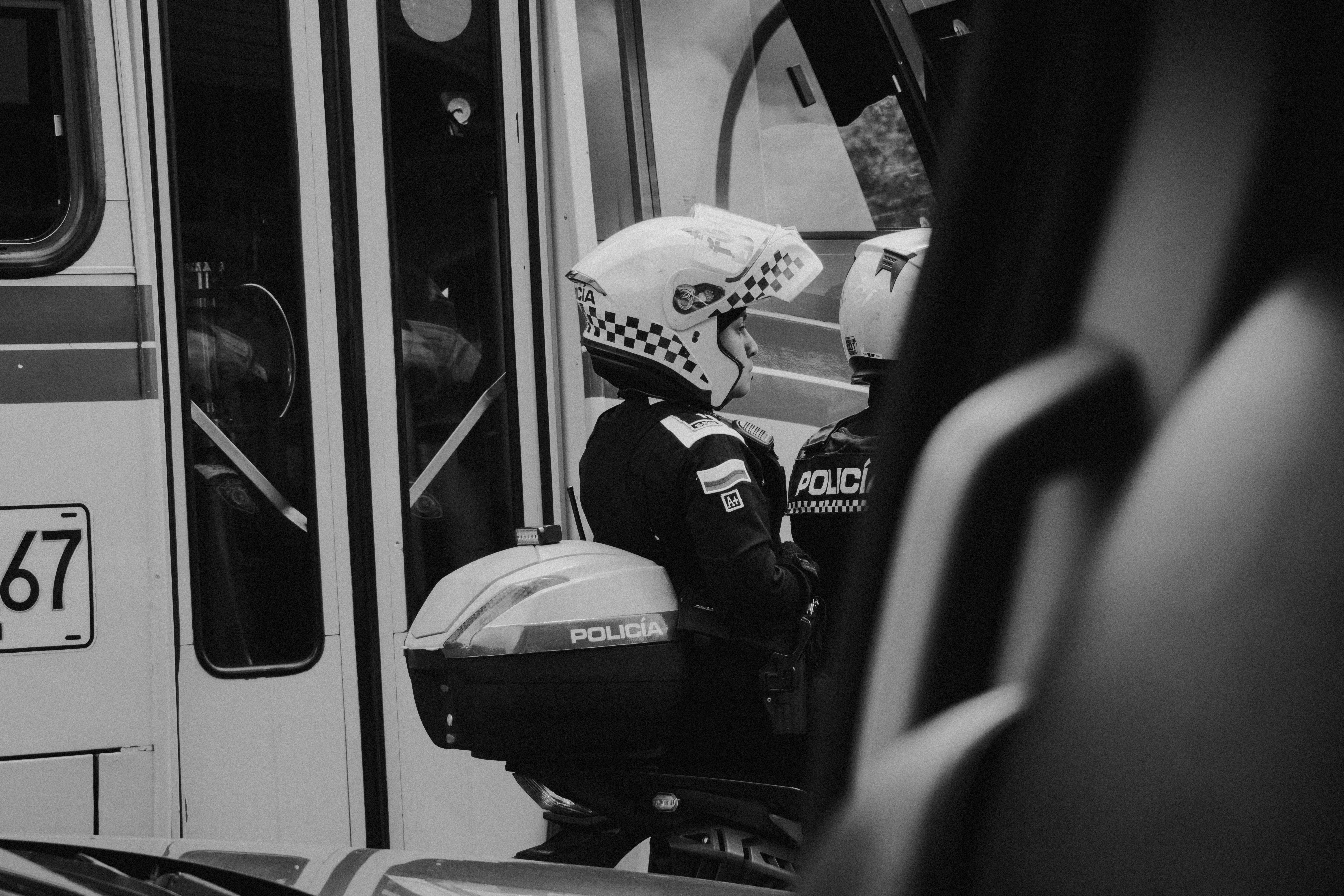 Quiet Standby: Police Motorcycle at the Edge of a Bus Door