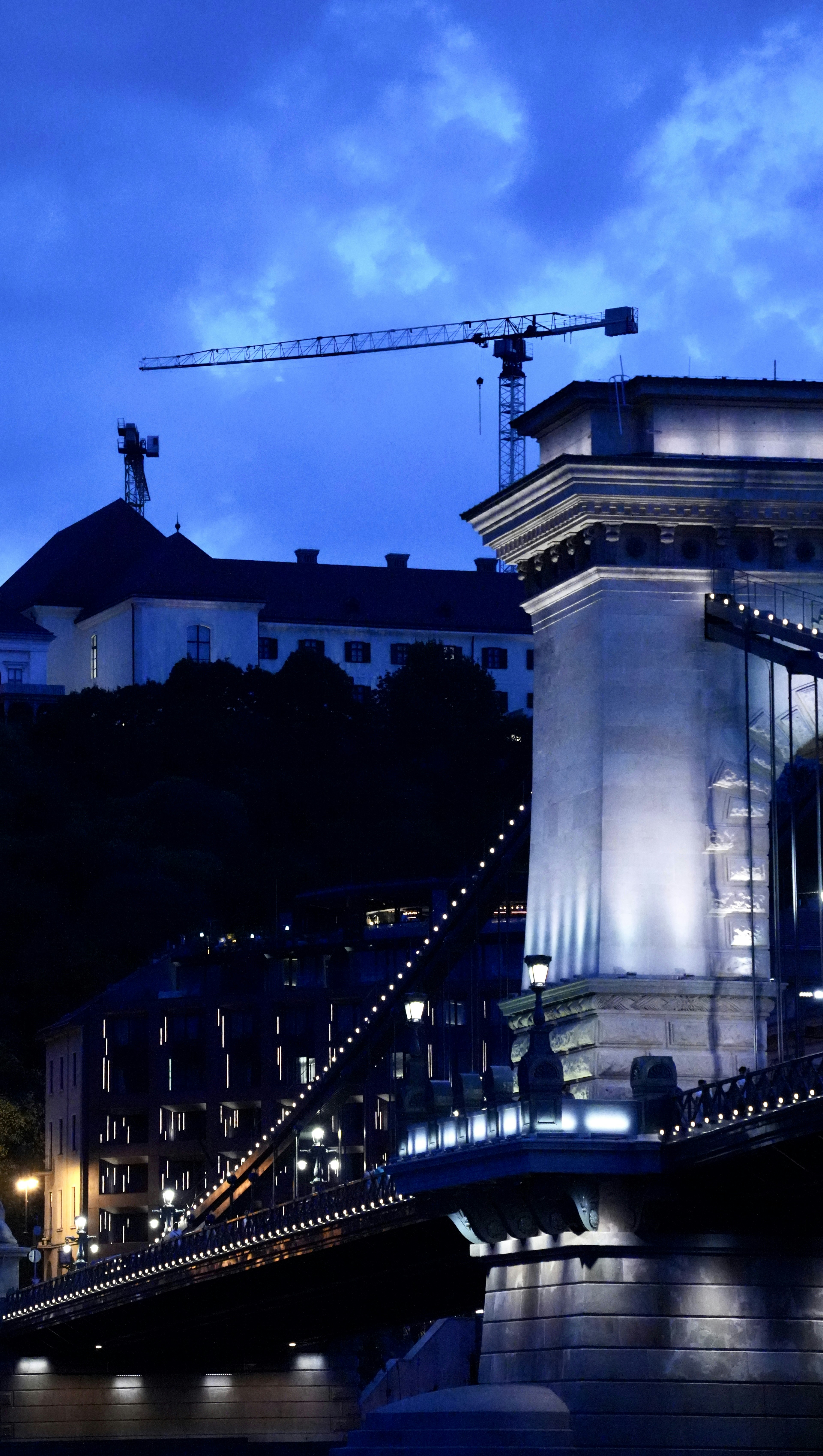 Blue Hour Bridle: Lighted Bridge Cascades Over a Quiet City
