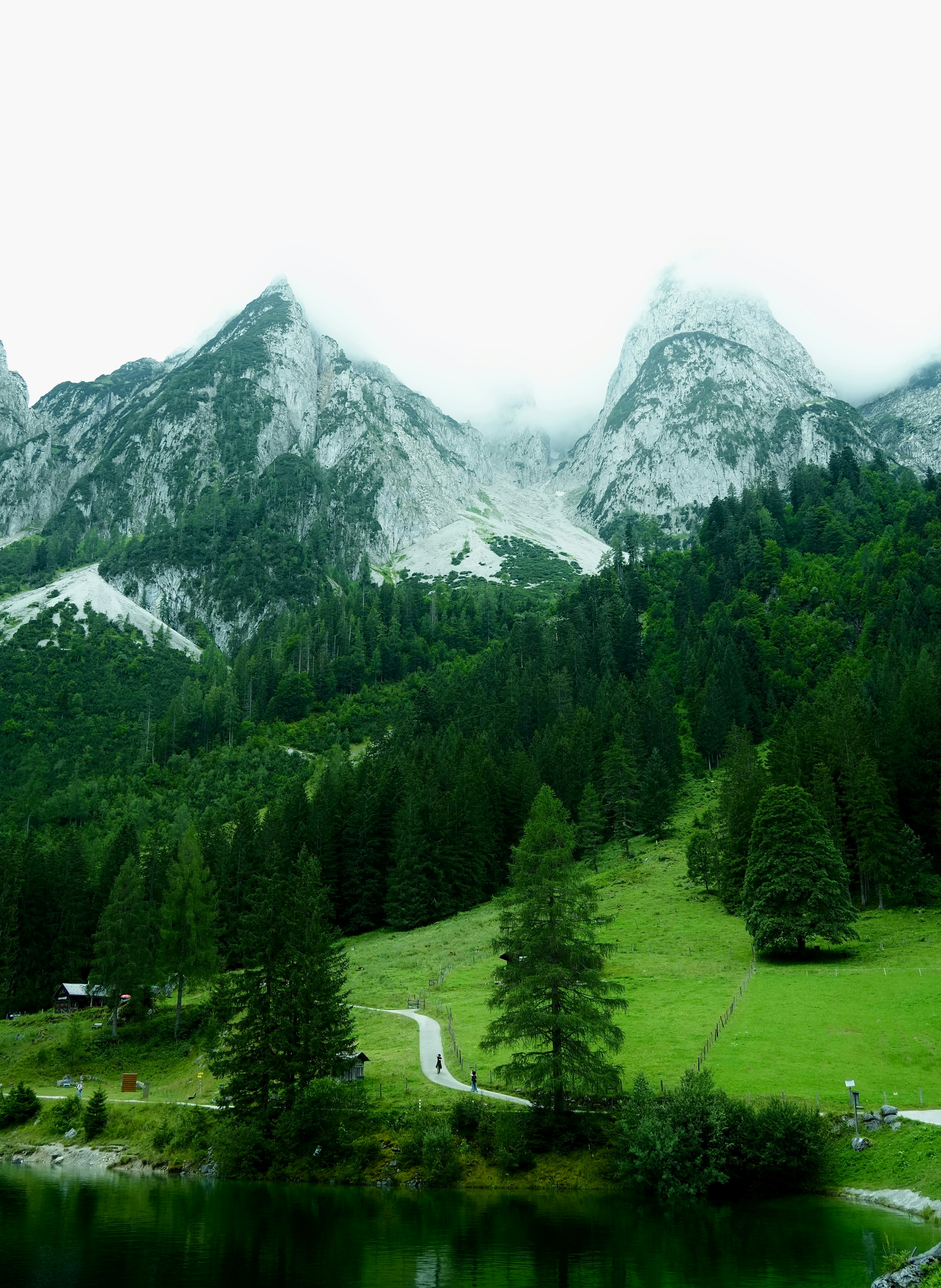 Cascade of peaks: valley path winding toward snow-topped giants