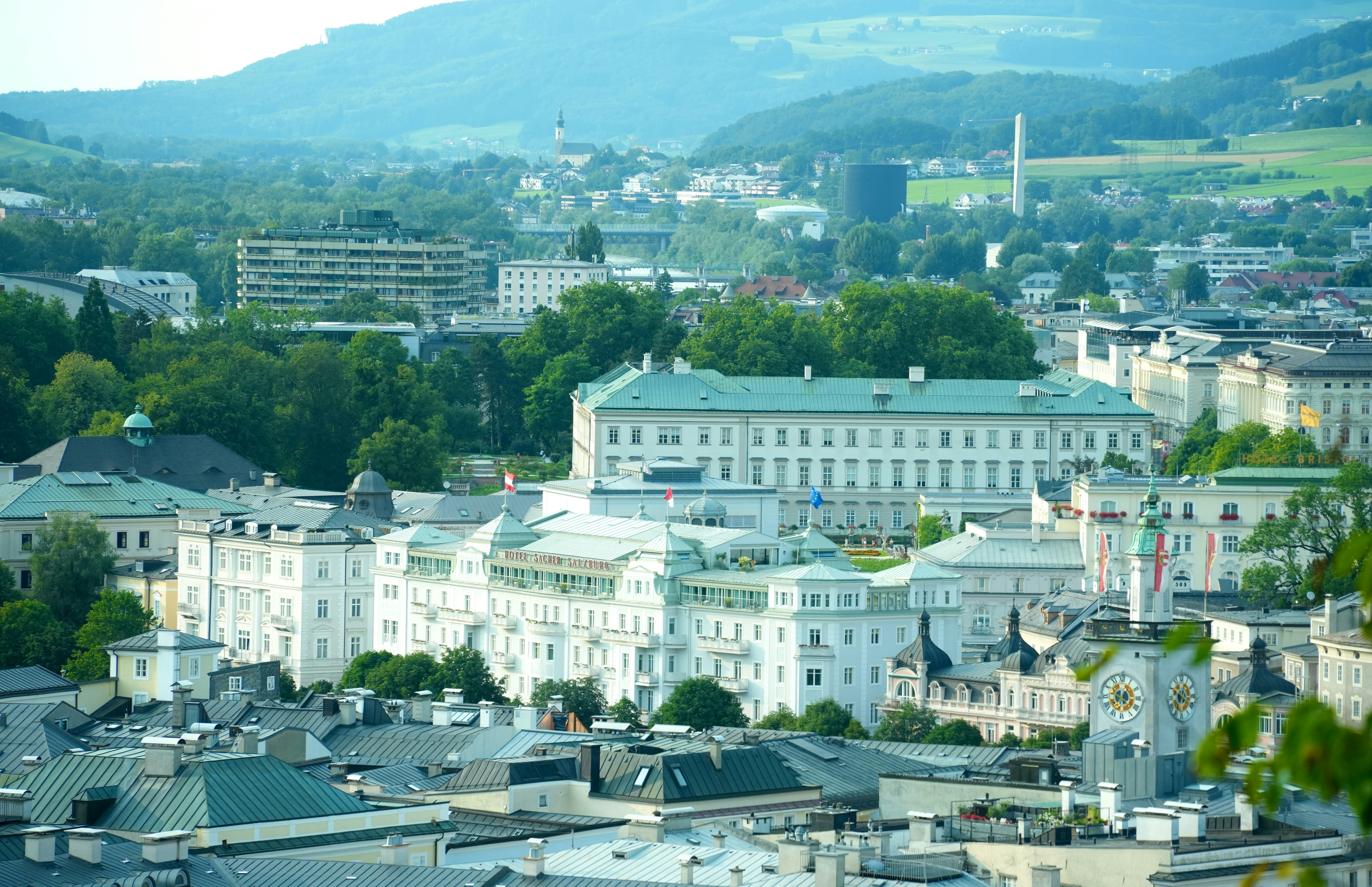 Aerial Symphony: White Facades Rest beneath a Quiet Alpine Horizon