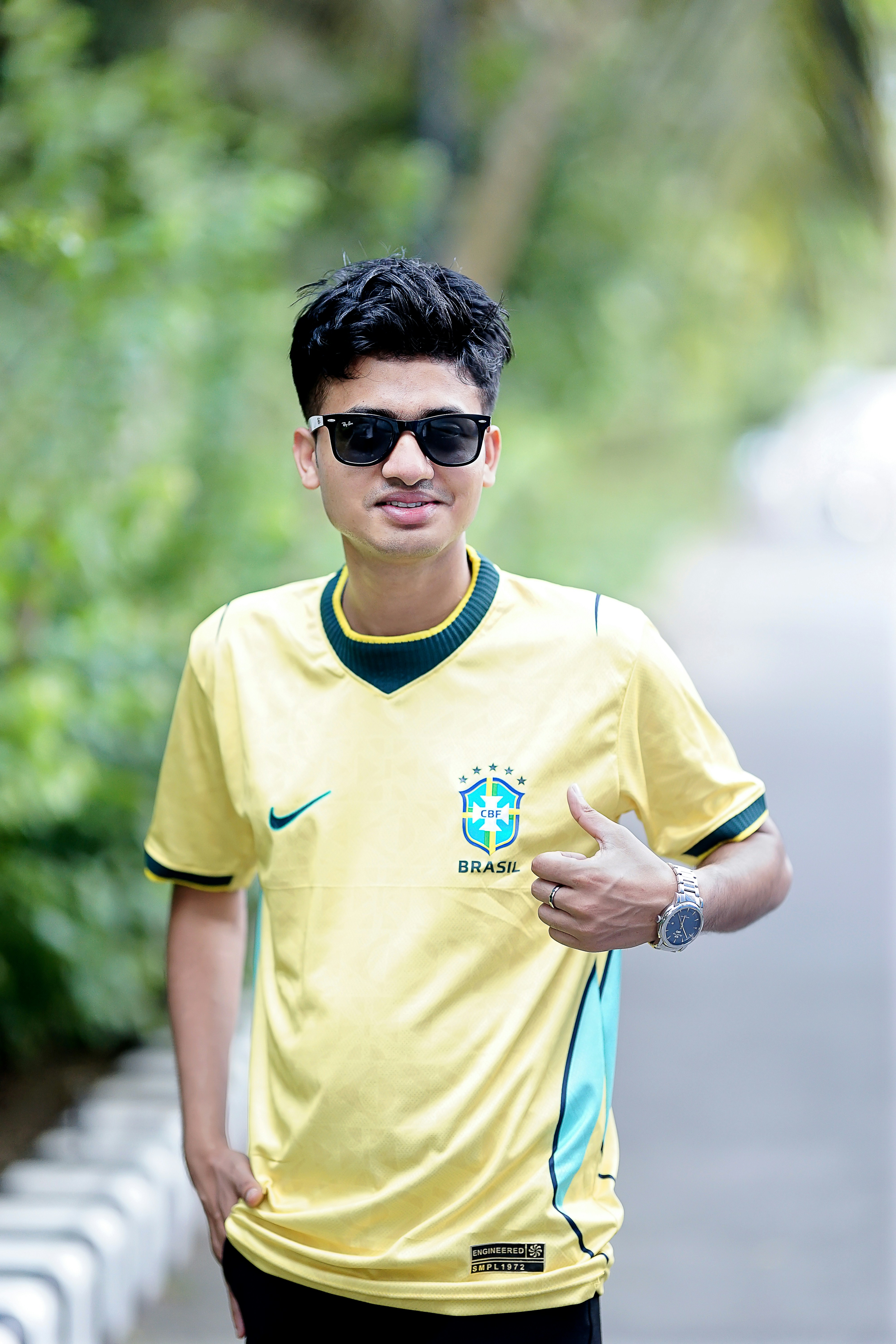 Bright Youth in Brazil Jersey Gives a Thumbs-Up Pose