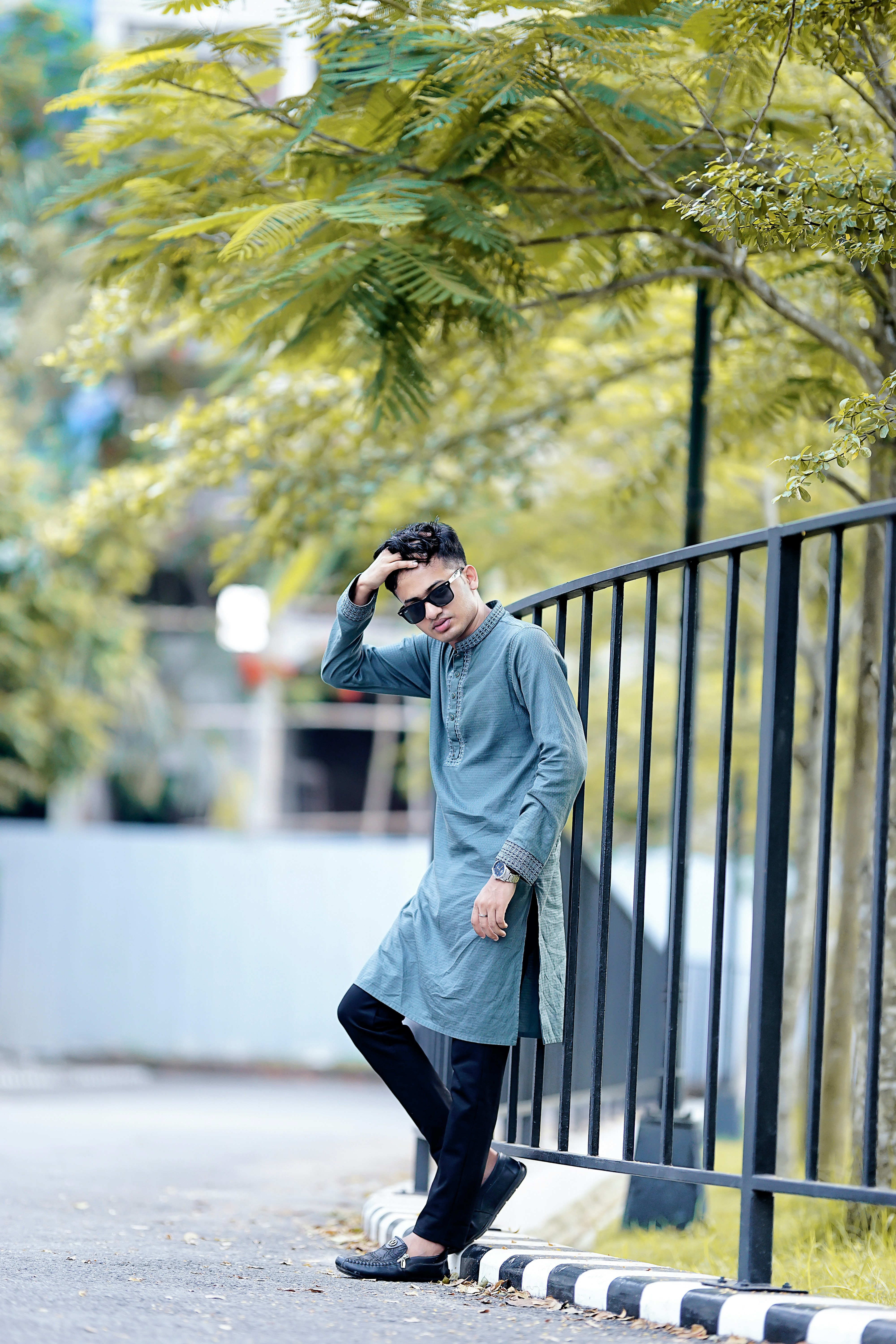 Urban Corridor Pose: A Casual Portrait by the Fence